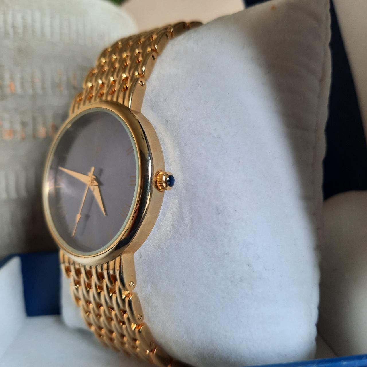 Gold chain watch with metallic sapphire blue clock... - Depop