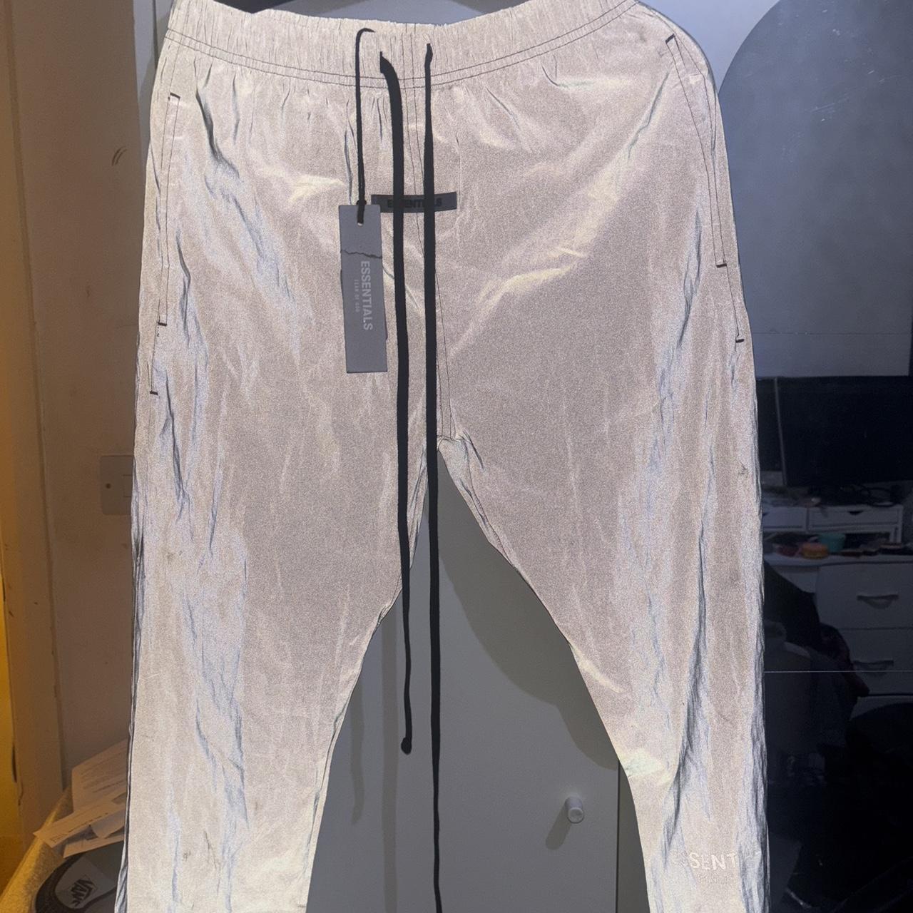 Fear of God Essentials reflective grey track pants... | Depop