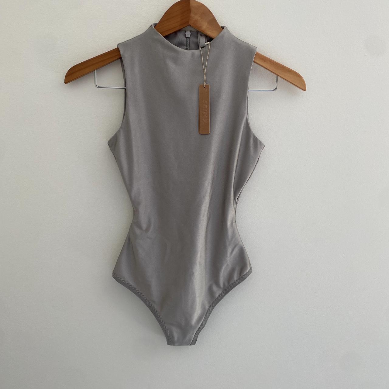 skims silver brand new body suit in almost perfect... - Depop
