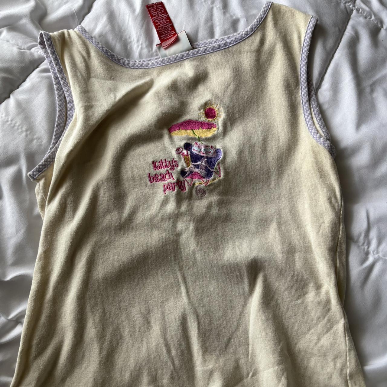 Light yellow tank top with purple trim and an... - Depop