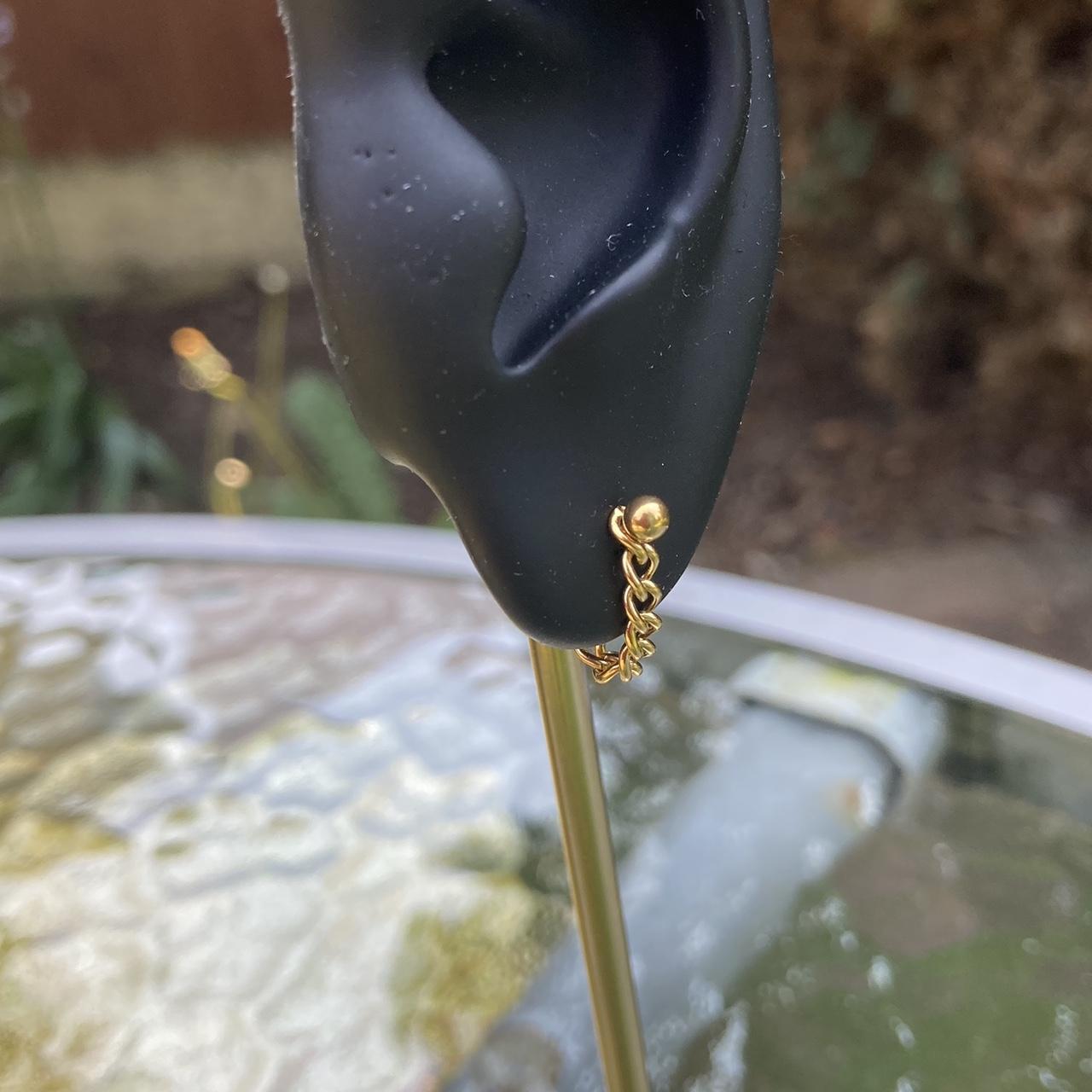 1 piece Gold tone dangling chain and barbell... - Depop