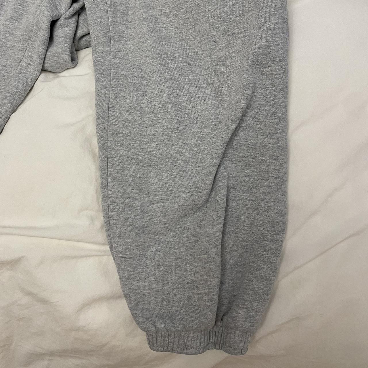 grey tna sweatpants, cuffed leg size m, small stain... - Depop