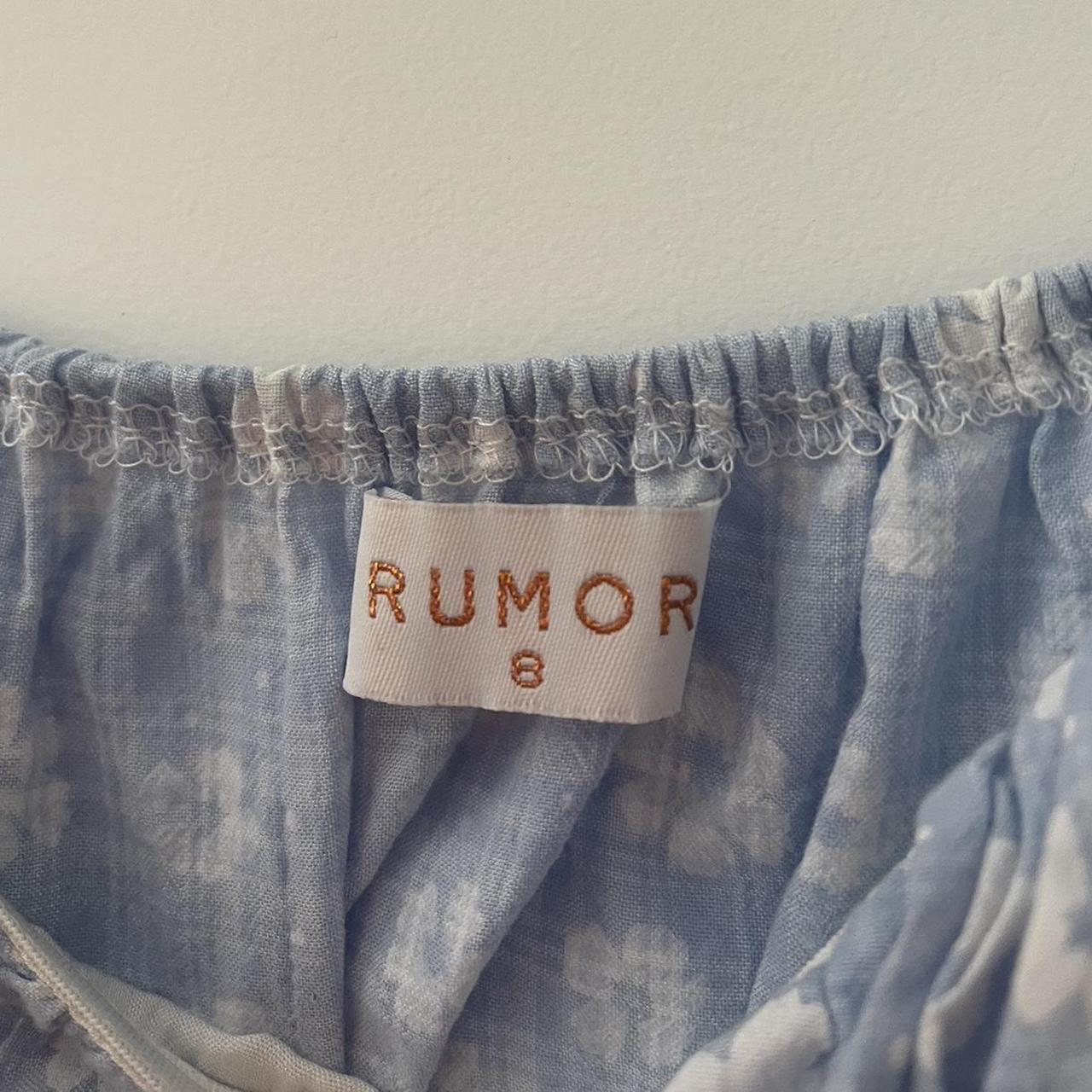 Blue ‘Rumor’ top with white flower petals in a size... - Depop