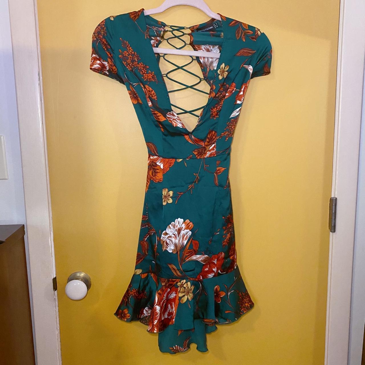 Deep cut green floral romper with lace-up back.... - Depop