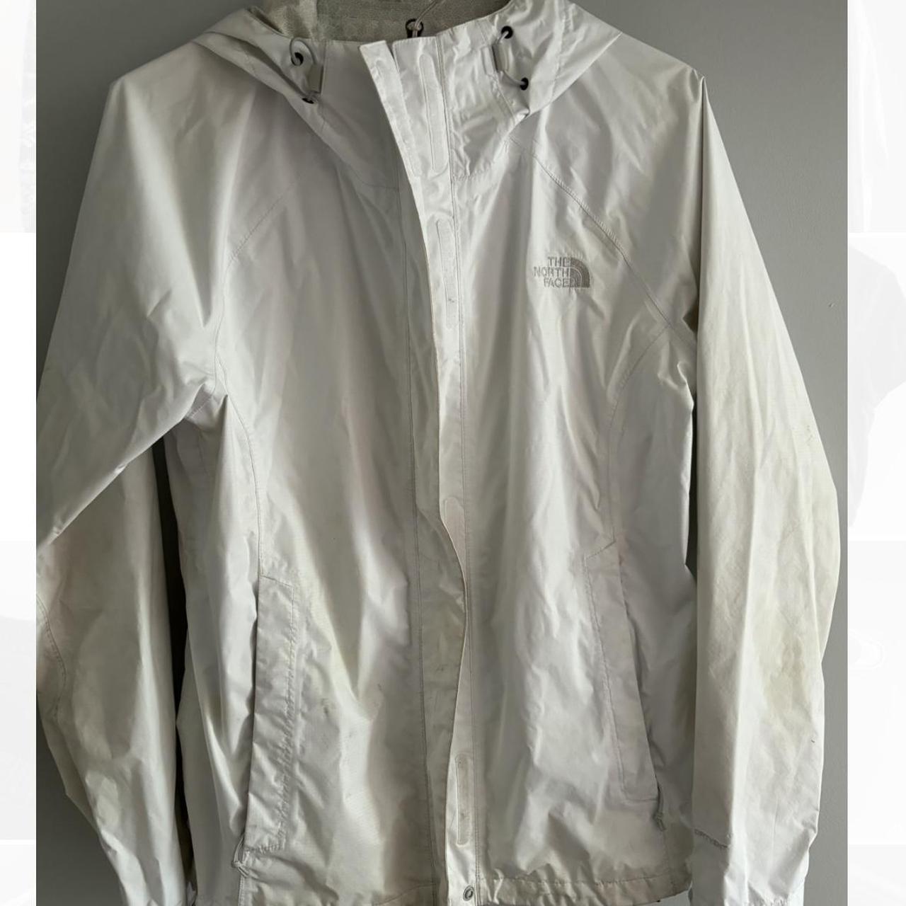 North Face white rain jacket. Worn with few small... - Depop