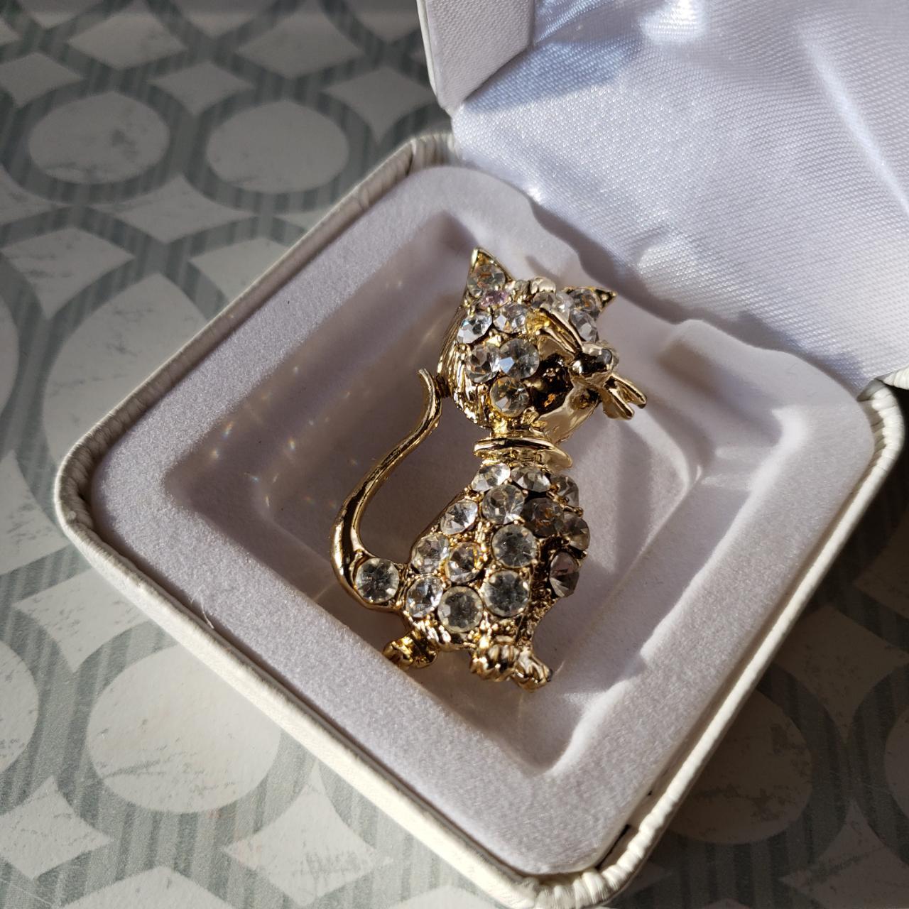 Gold cat brooch covered in cubic zirconia. Comes in... - Depop