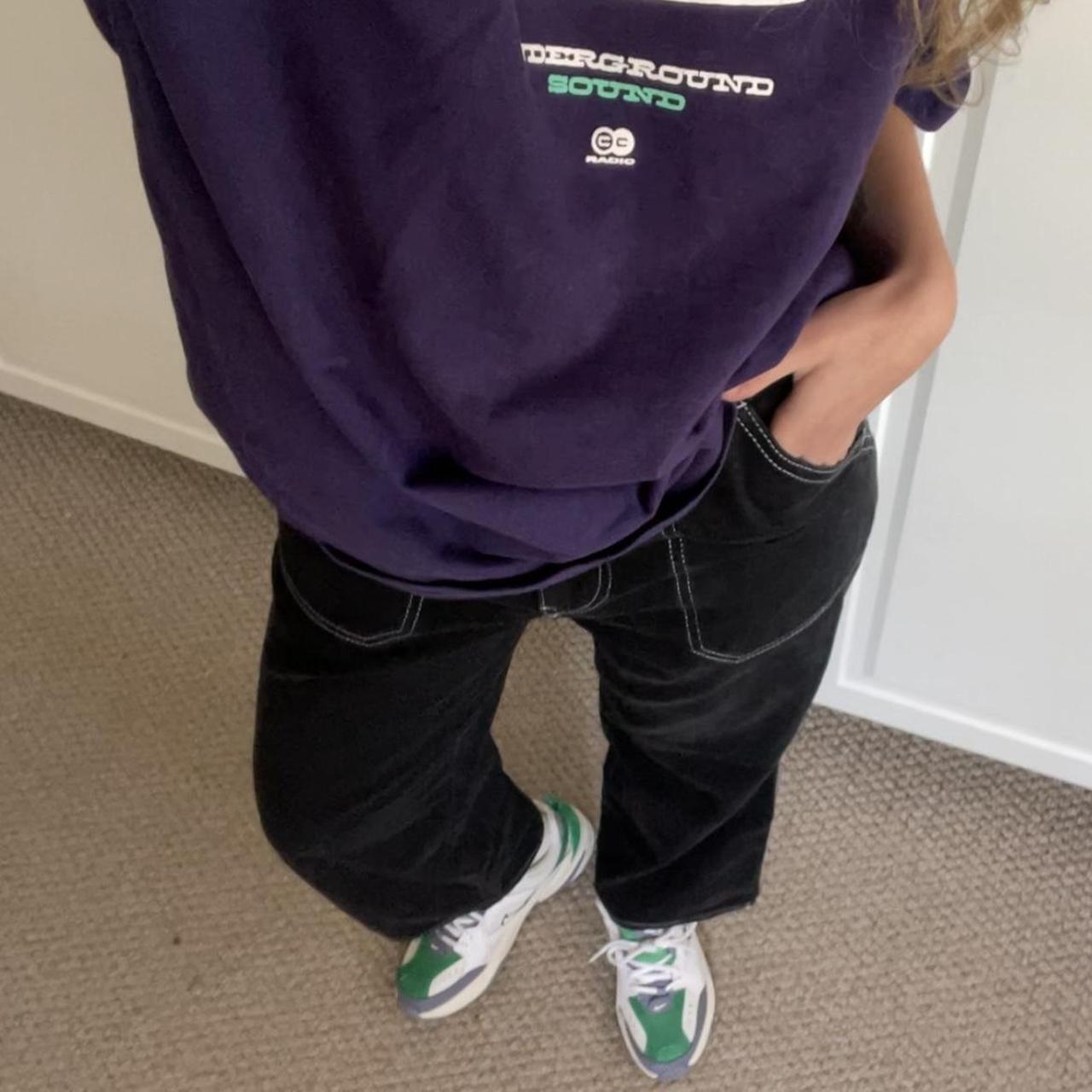 black lioness-style pants with white stitching... - Depop