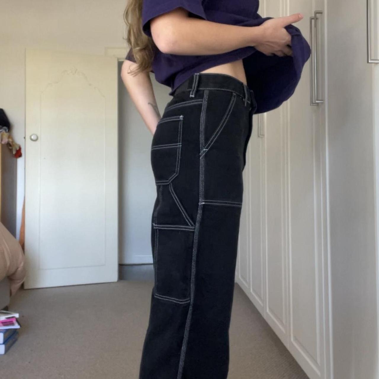 black lioness-style pants with white stitching... - Depop