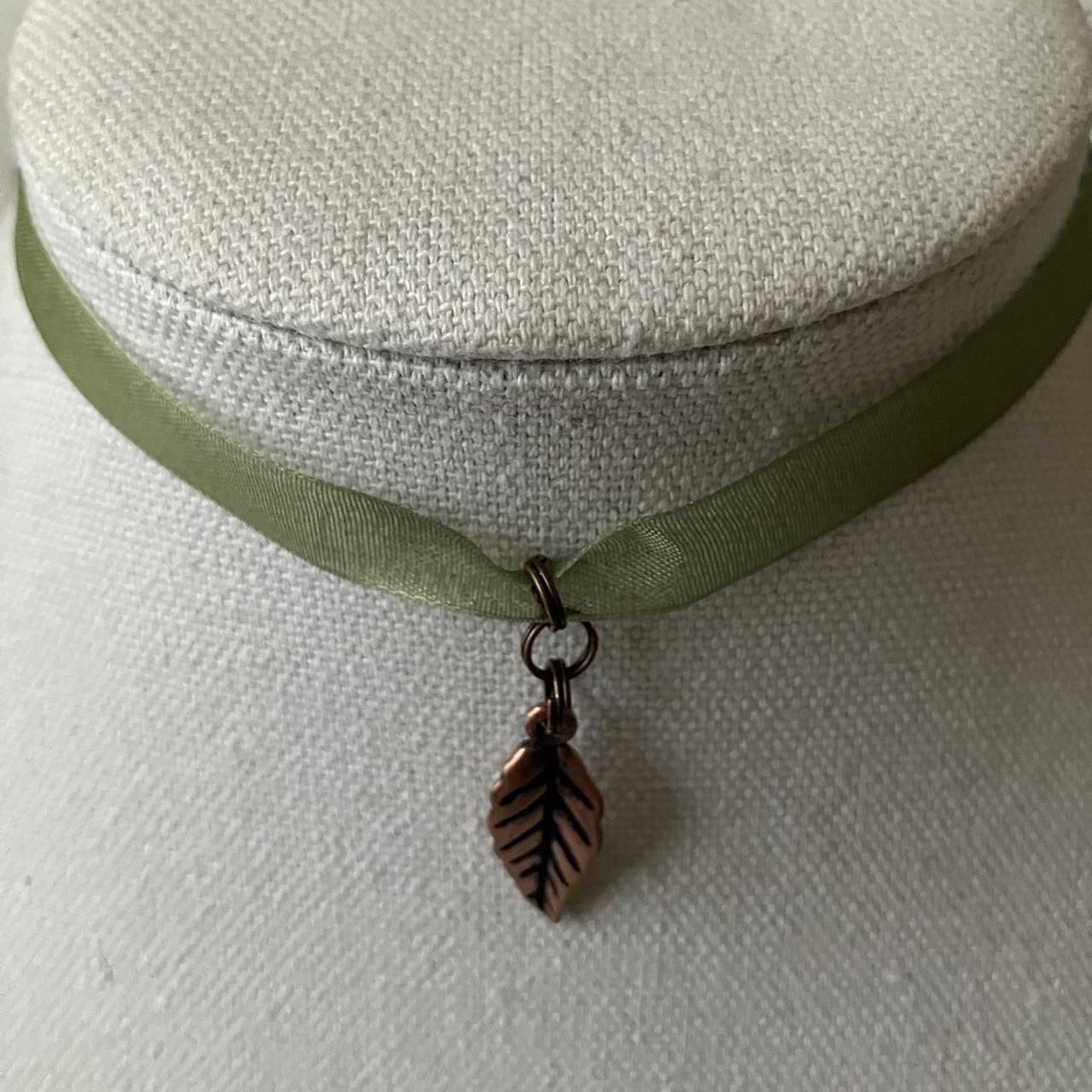 Rich coppertone etched leaf charm on sheer khaki... | Depop
