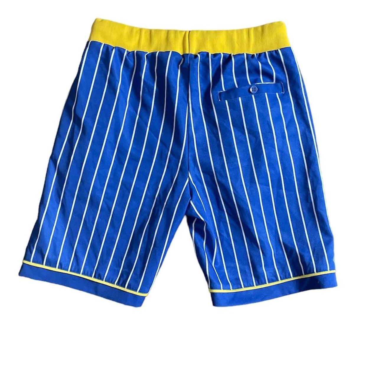 Made in The City blue and yellow shorts. With text... - Depop