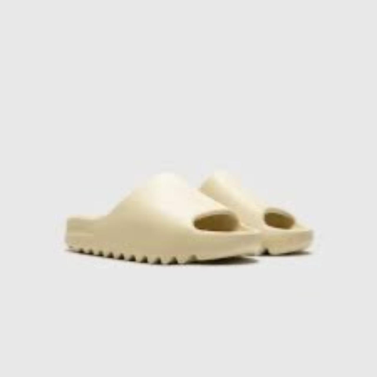 The Adidas Yeezy White Slides are a perfect blend of... - Depop
