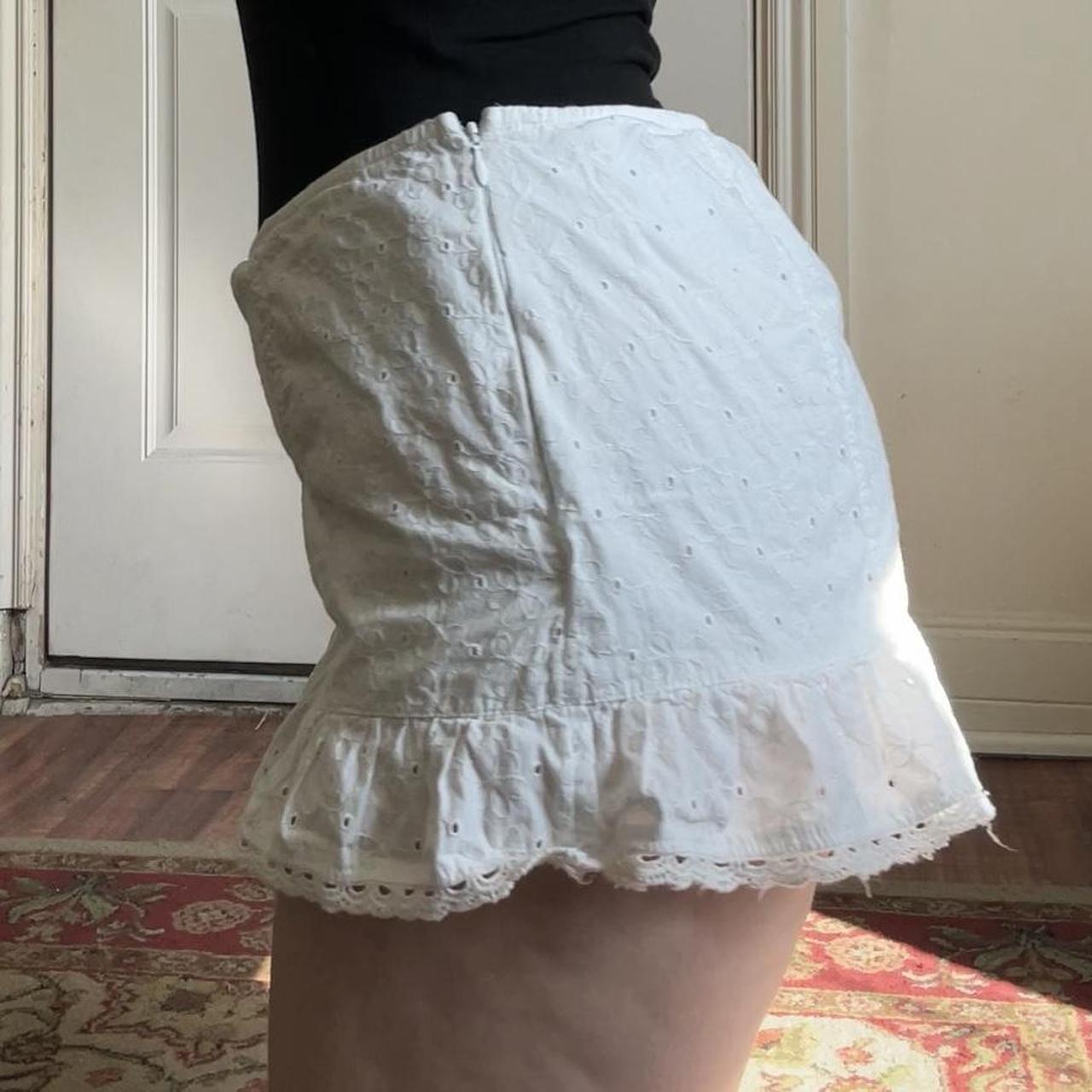 white (very) mini skirt with lace details! has small... | Depop