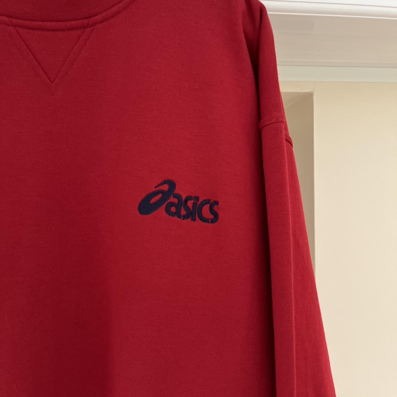Red Asics jumper with embroidered navy spell out on... - Depop