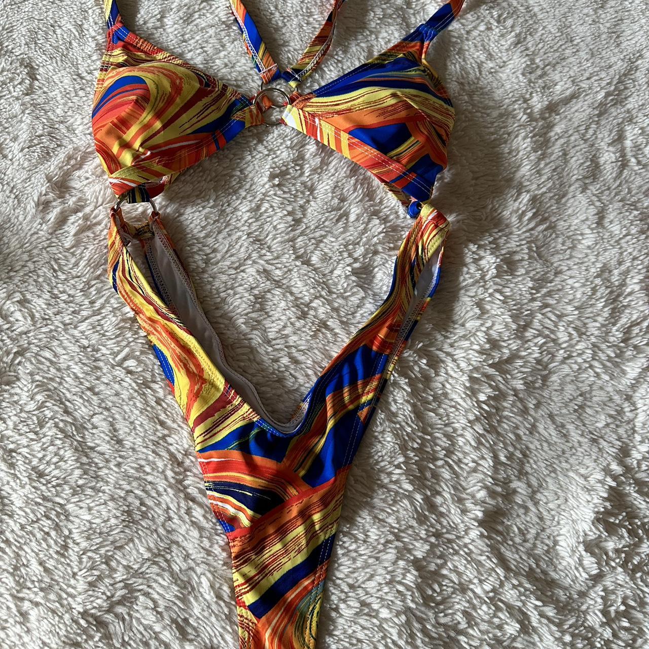 Multi color V-cut 1 piece swim. Never worn. No tags. - Depop