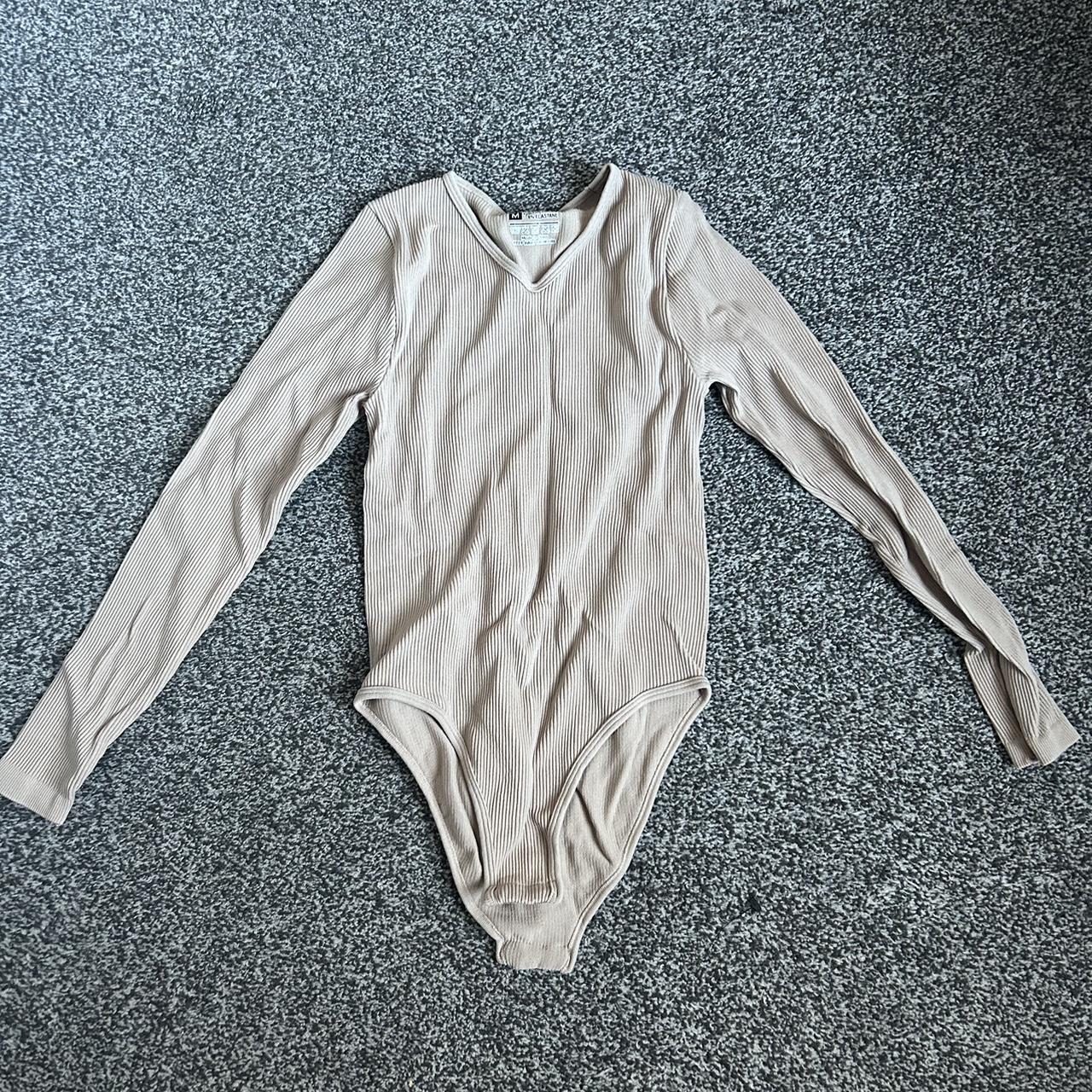 Prettylittlething beige v-neck ribbed bodysuit! Size... - Depop