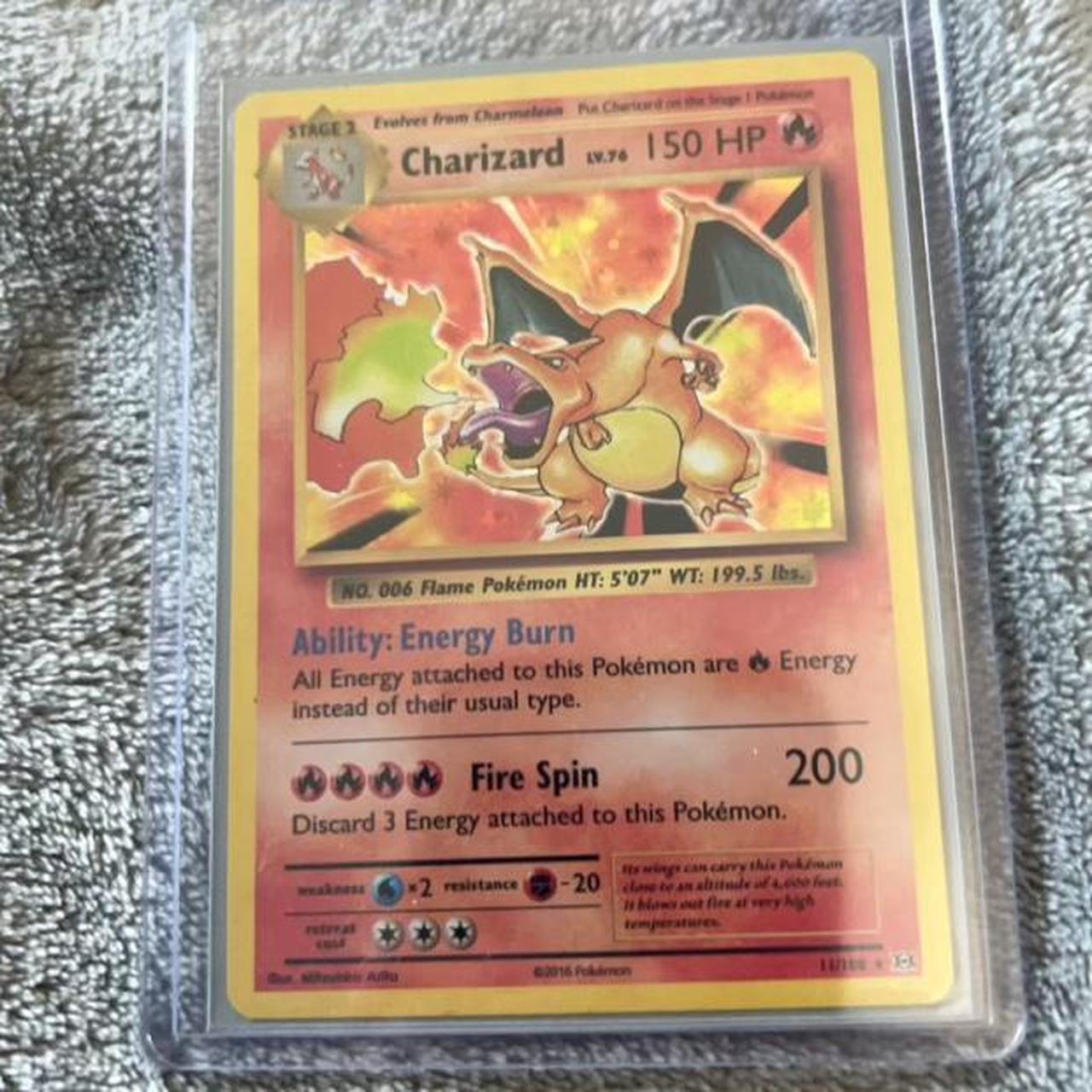 Pokémon Charizard card with hard card protector... - Depop