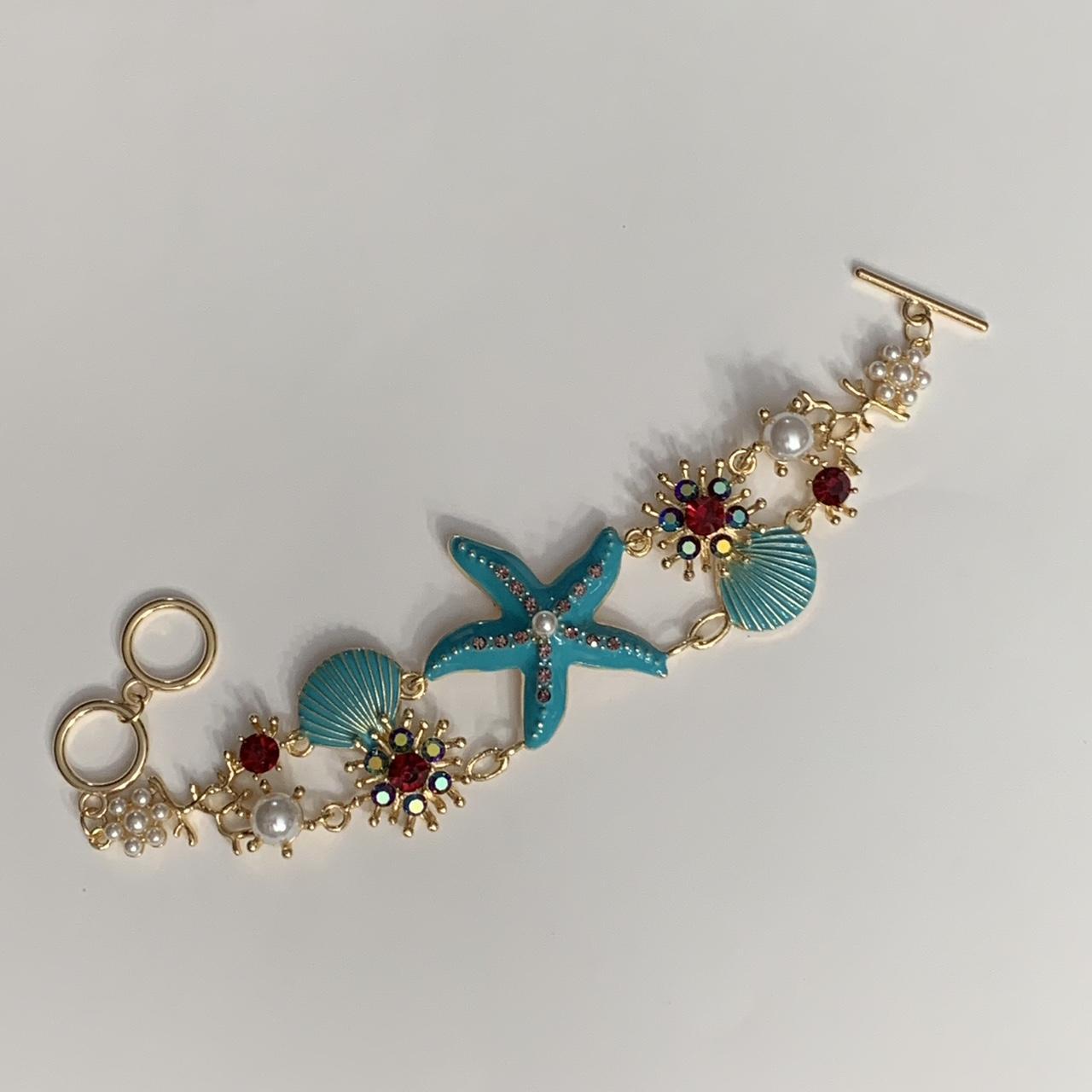 Gold tone sea life bracelet with starfish, shells,... | Depop