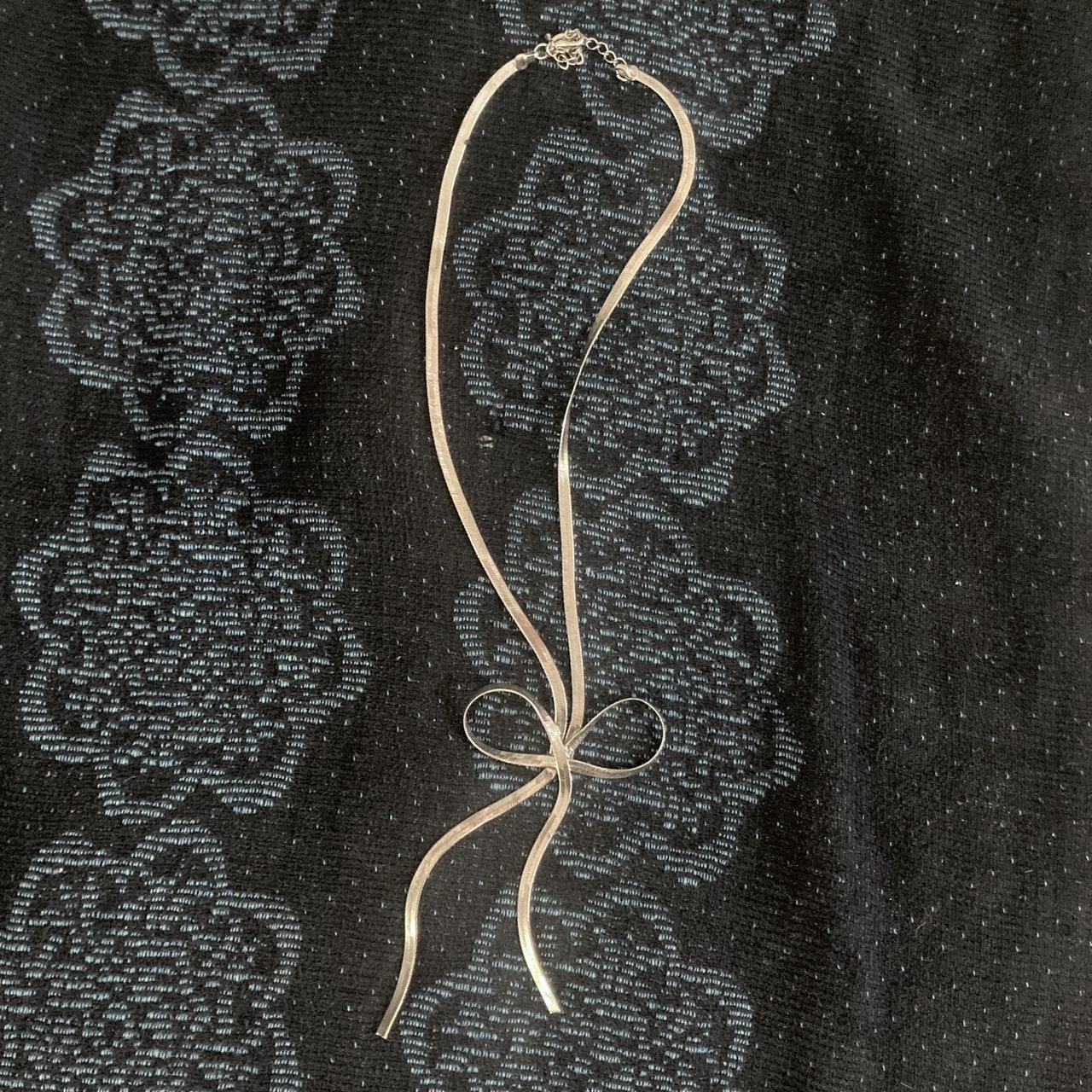 Silver Bow asymmetric ribbon style necklace Really... - Depop