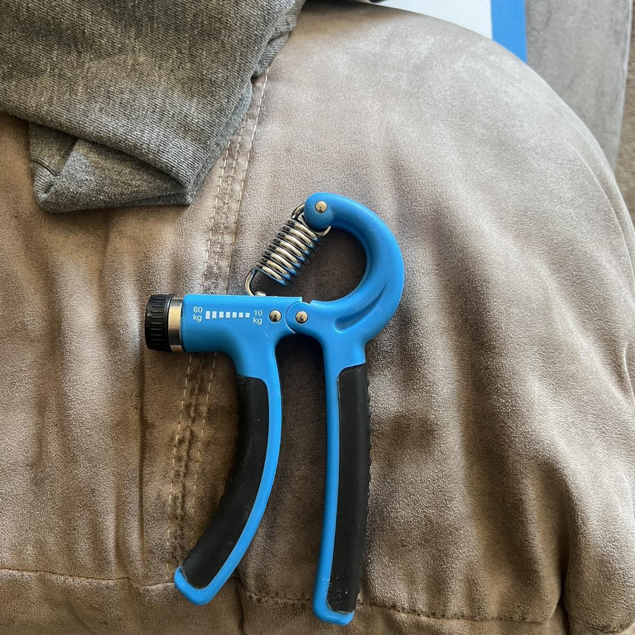 Blue hand gripper Good condition, still works, helps... - Depop