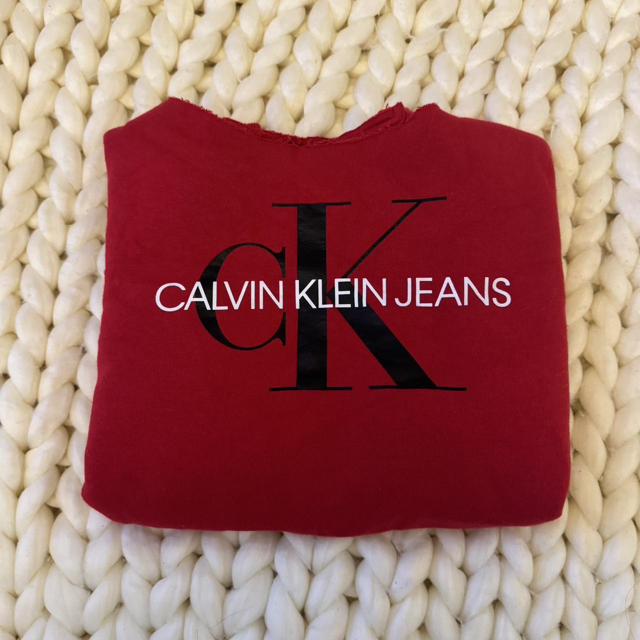 Red Calvin Klein Jean shoulder cut out sweatshirt... - Depop