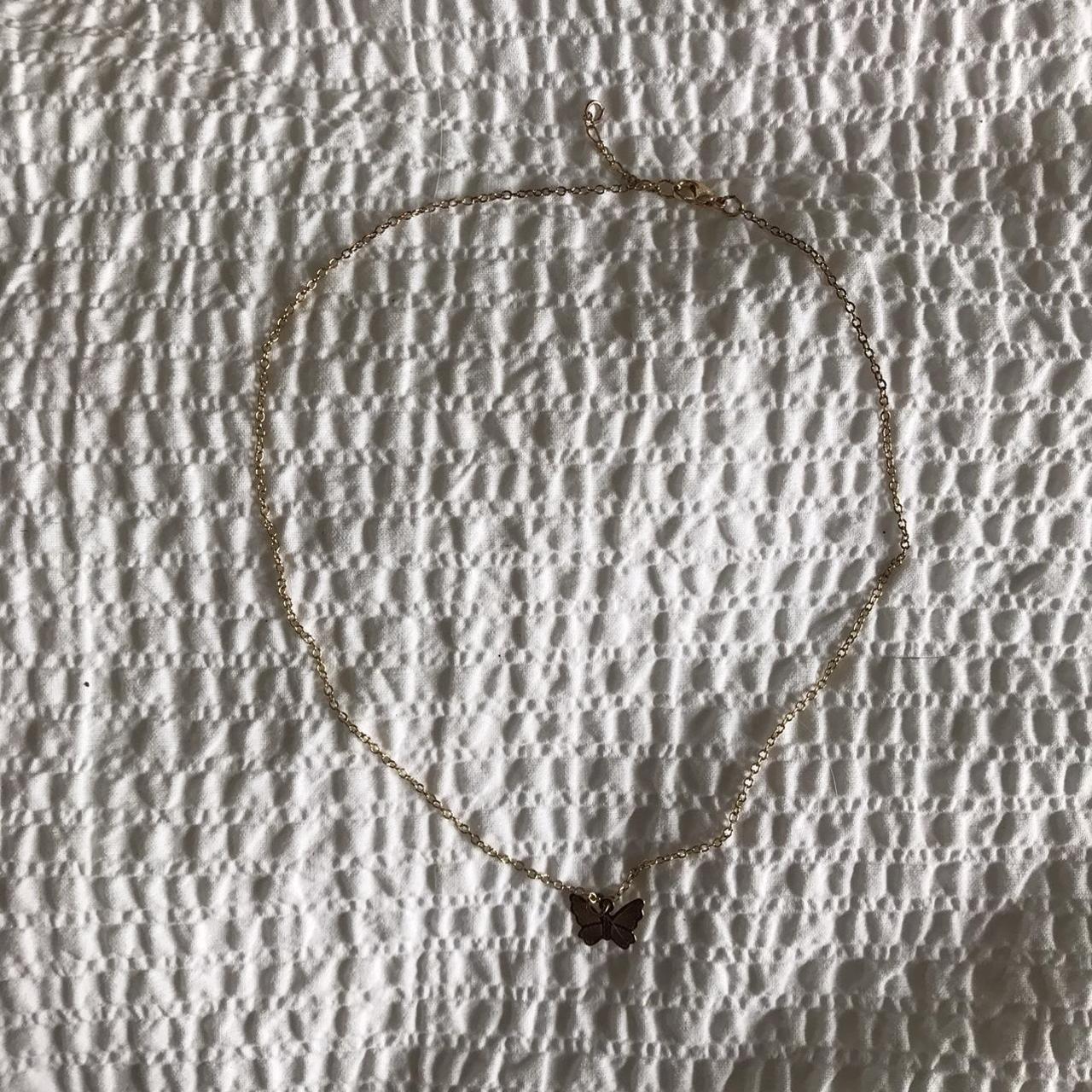 Butterfly charm necklace from Brandy Melville. Gold... - Depop