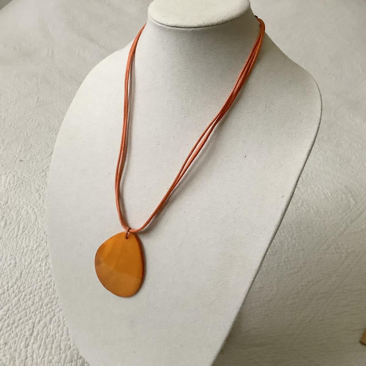 Bright orange iridescent sea shell pendant on triple... - Depop
