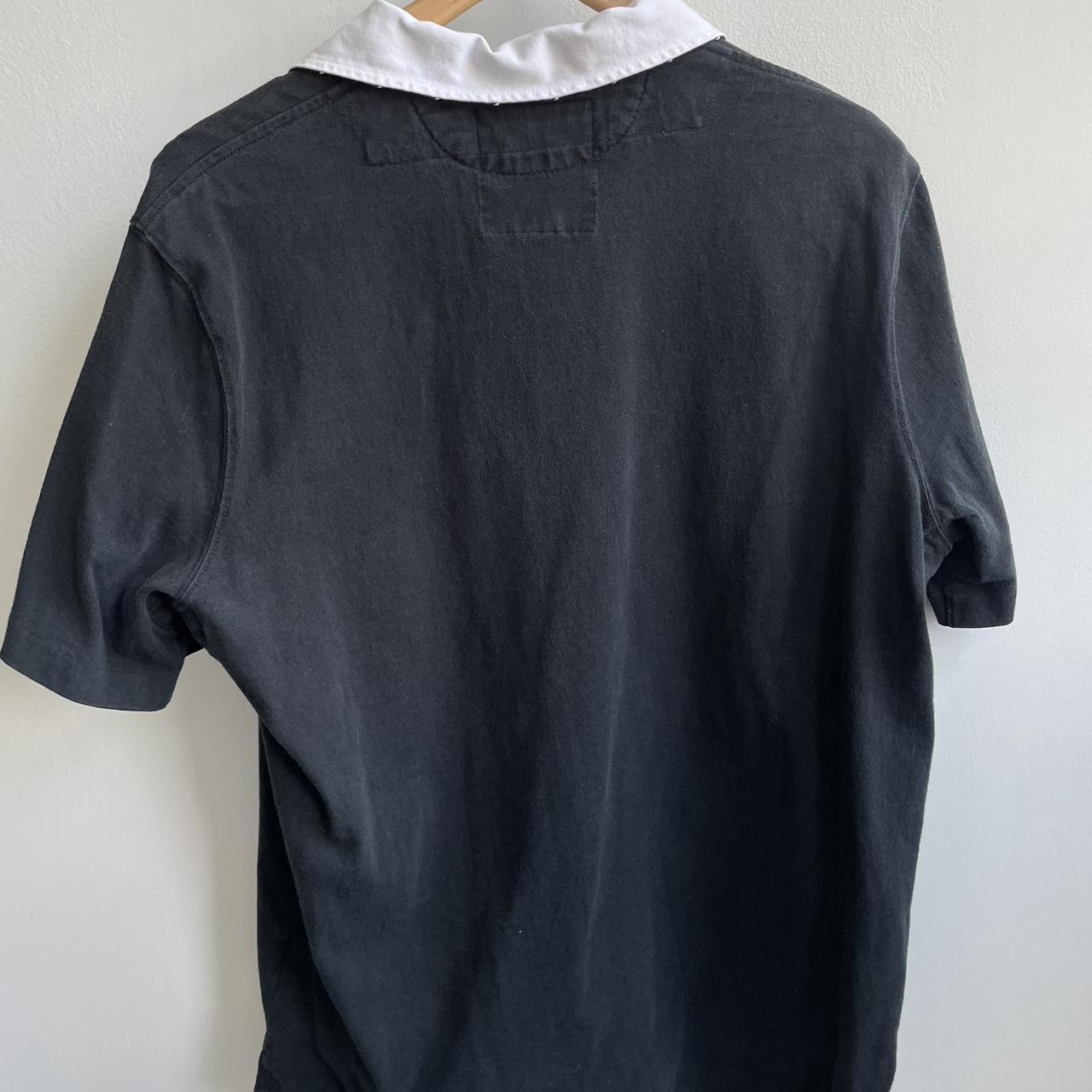 black polo top with skull and bones design. men’s... - Depop