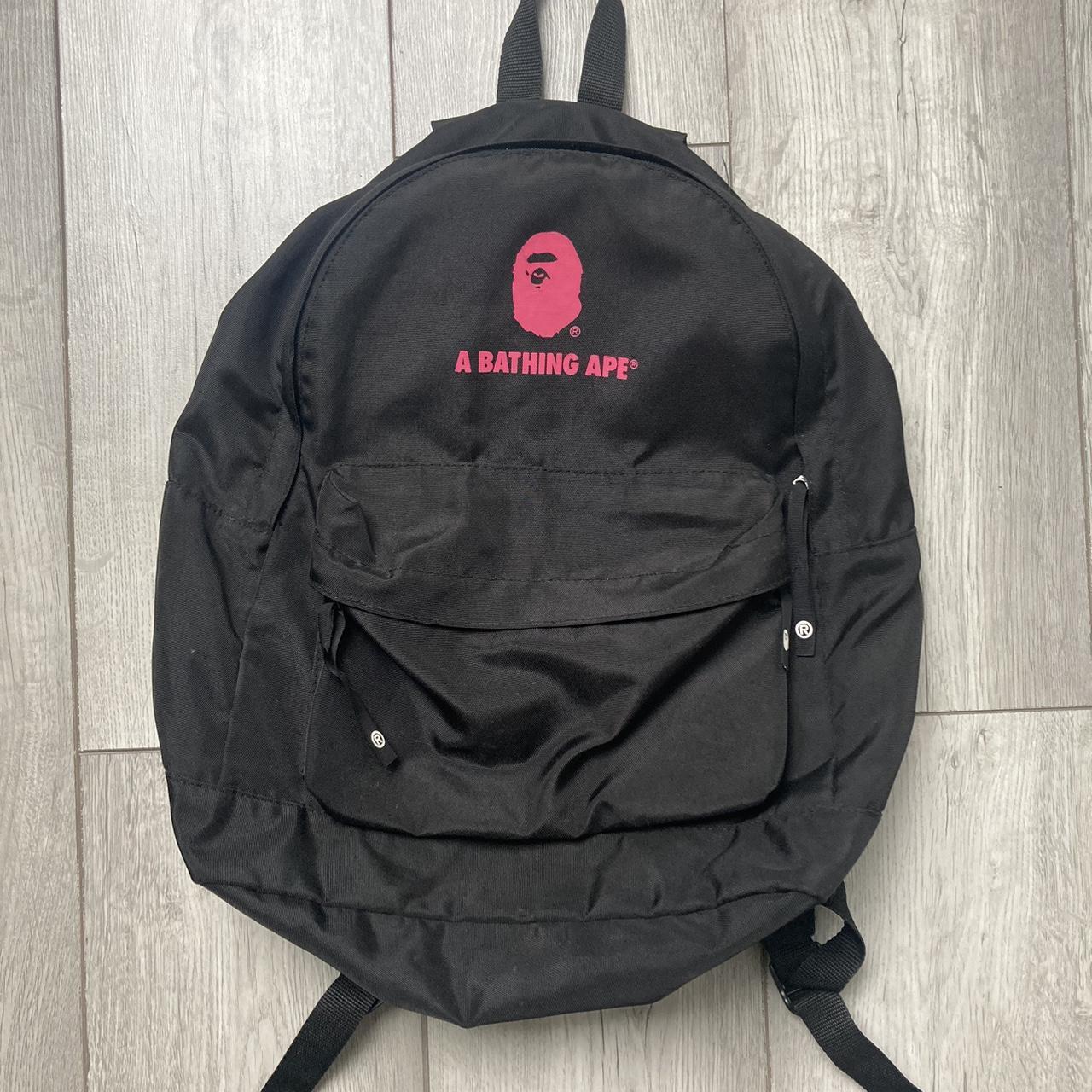 A Bathing Ape rucksack. Black with pink logo. - Depop