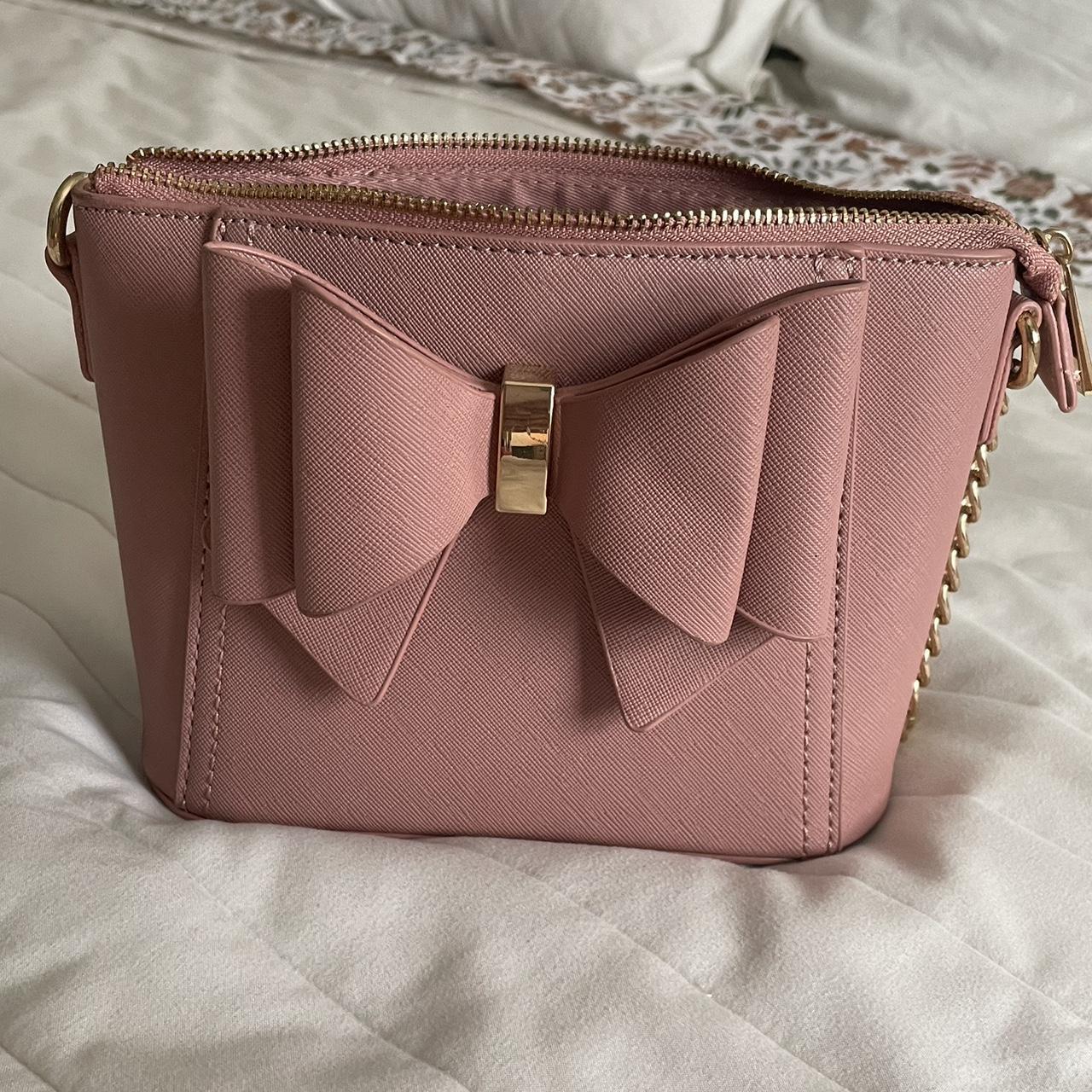 Pink bow purse with gold hardware. Pretty spacious,... - Depop