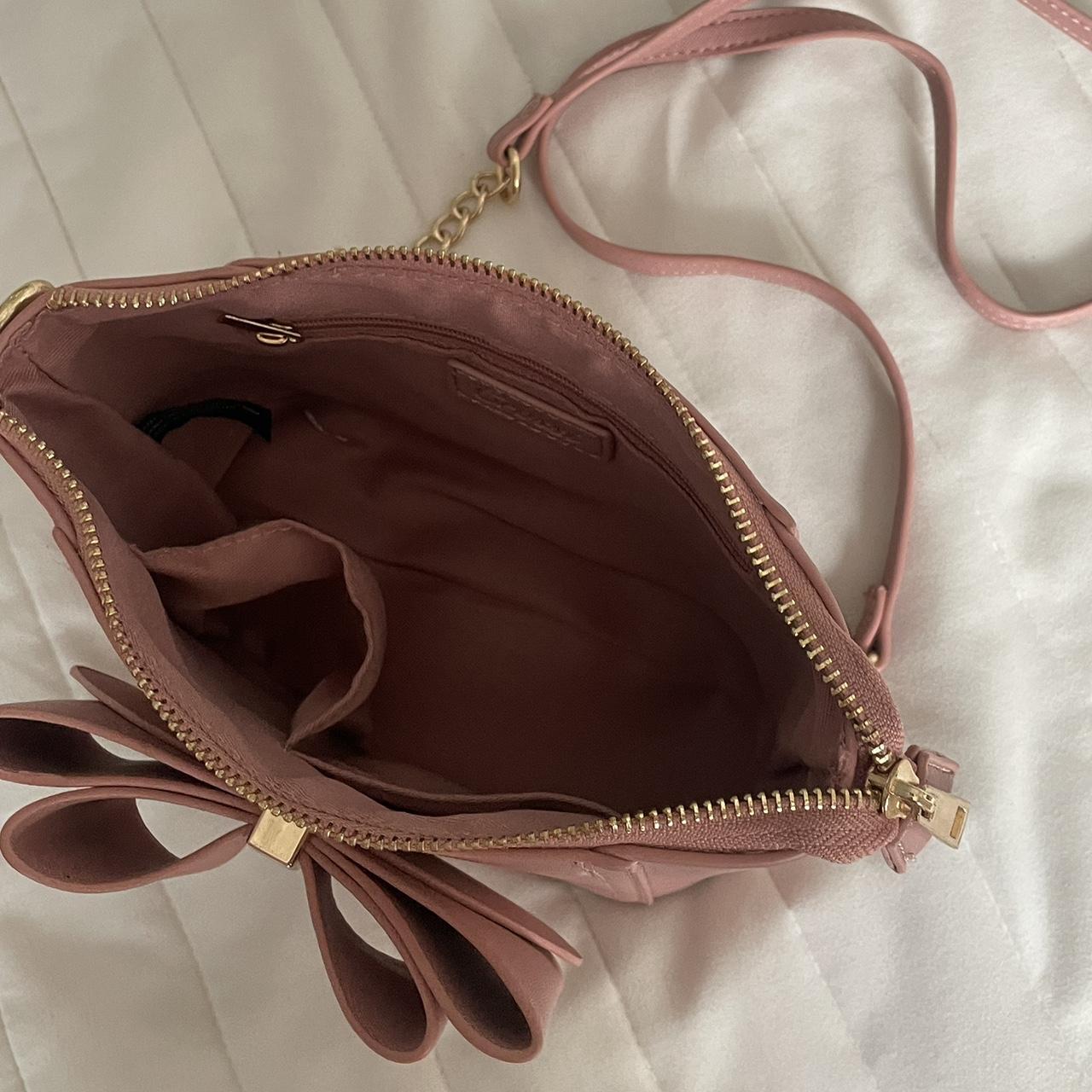 Pink bow purse with gold hardware. Pretty spacious,... - Depop