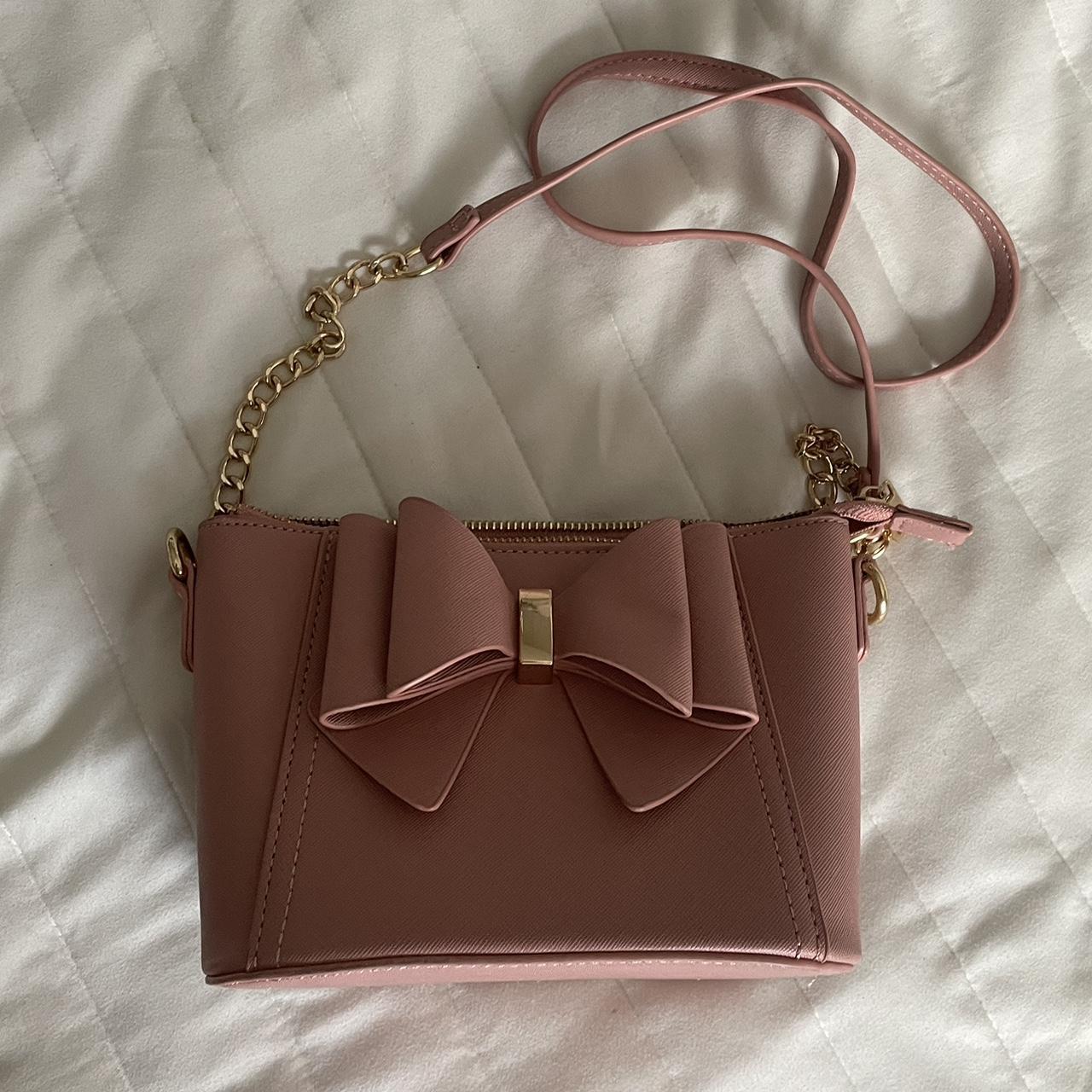 Pink bow purse with gold hardware. Pretty spacious,... - Depop