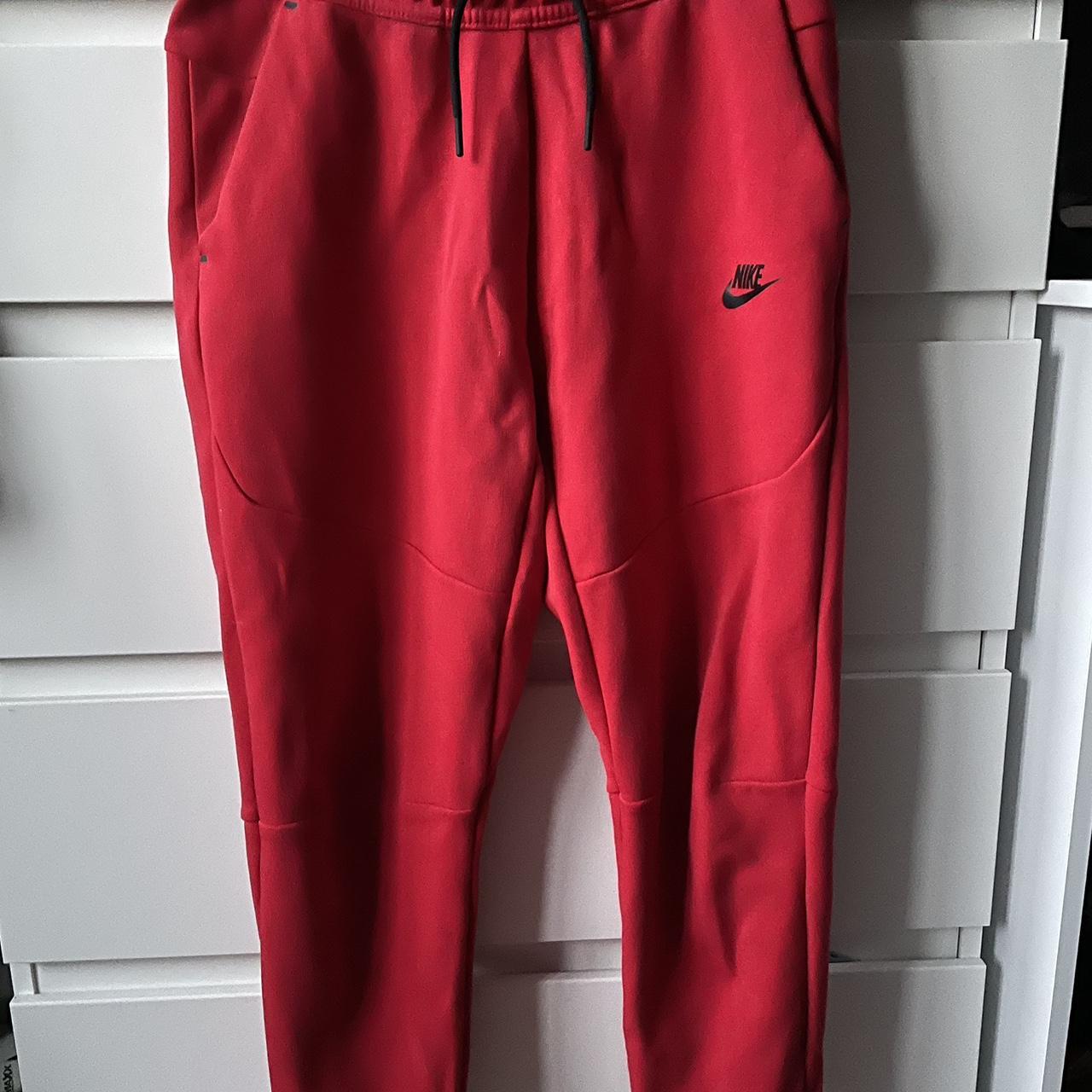 Red Nike Techfleece pants - Depop