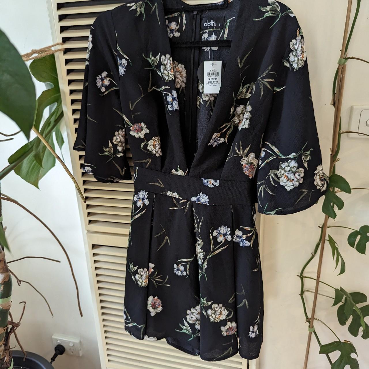 Black floral playsuit with tie back and deep V neck,... - Depop