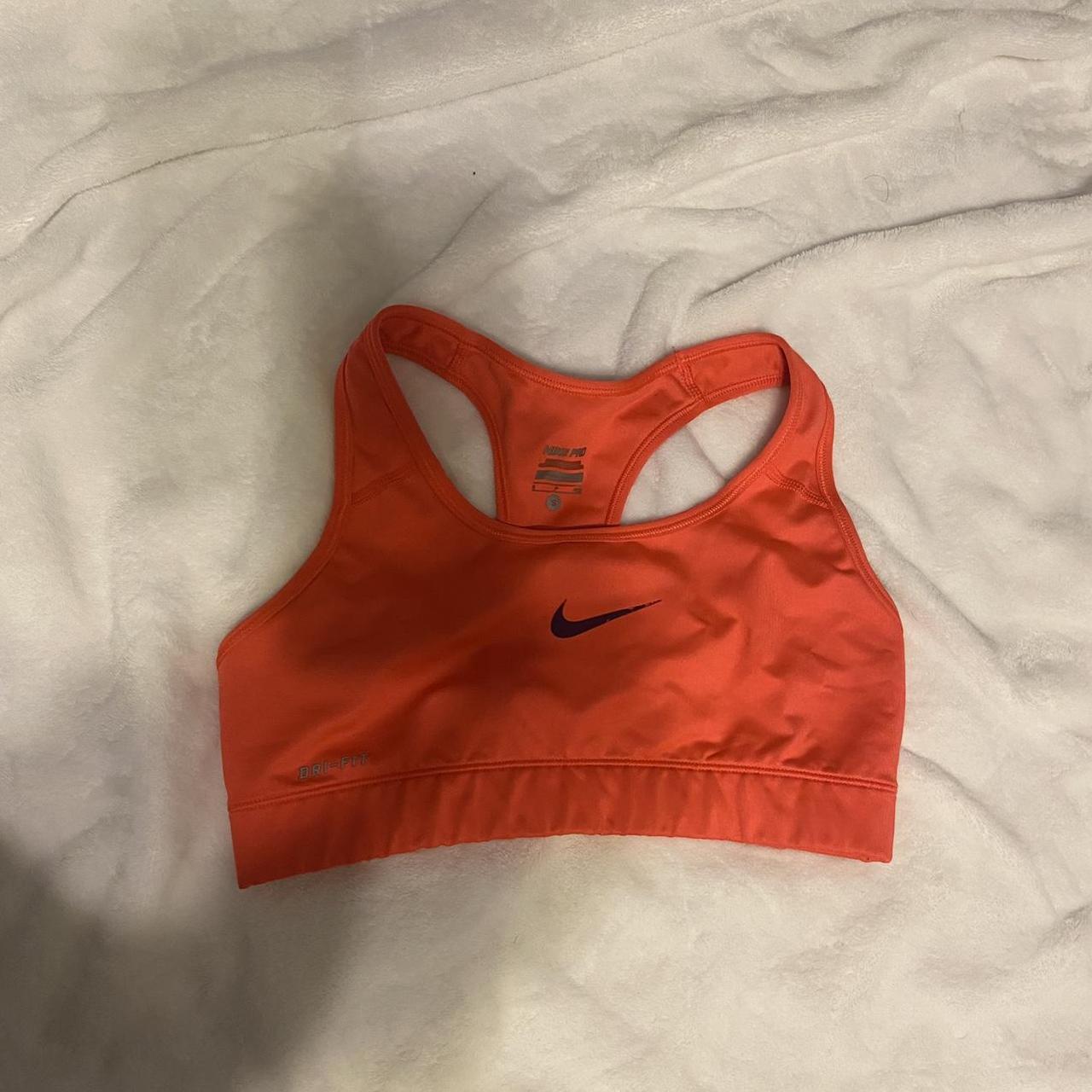 Bright orange sports bra with purple accents... - Depop