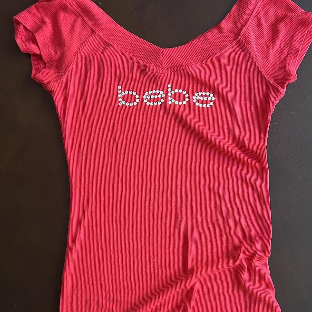 Bebe shirt v neck size M in colors blue is sold.... - Depop