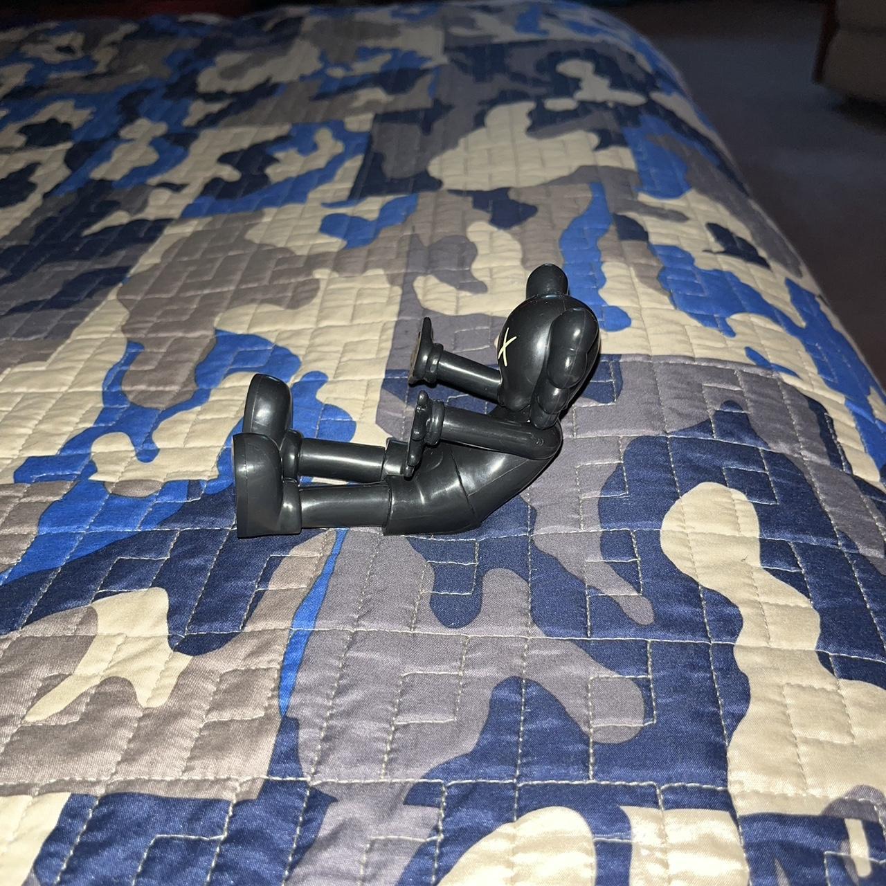 kaws black figure it lays down perfect condition... - Depop