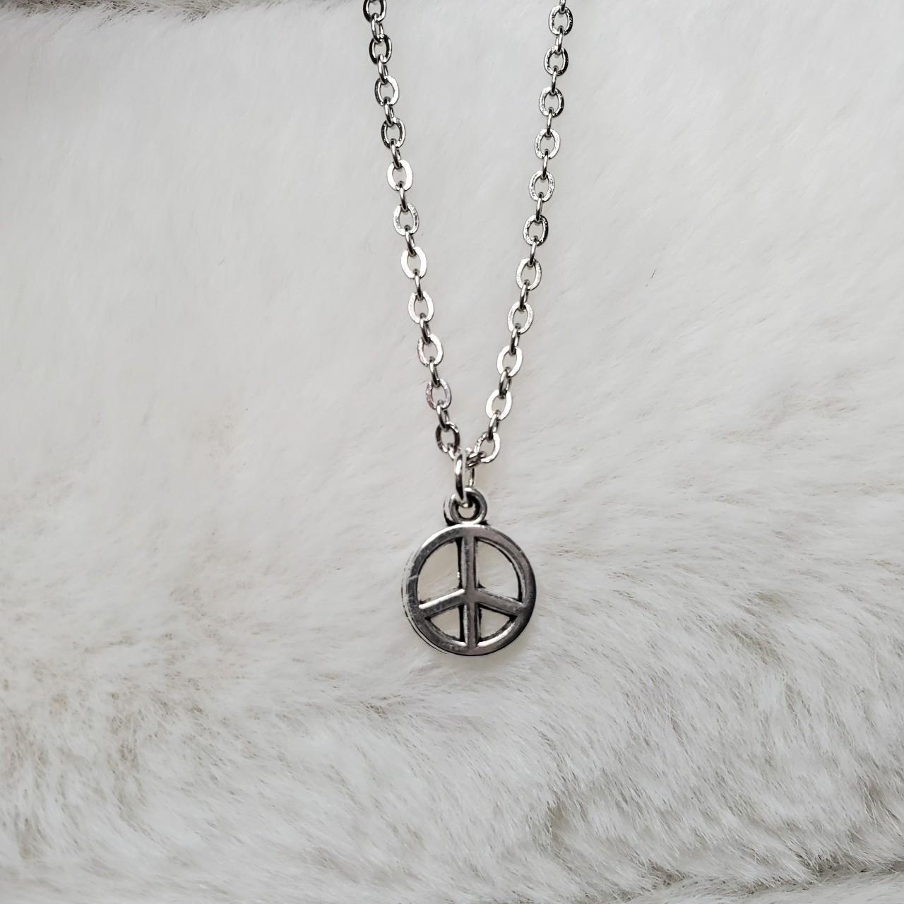 Tiny peace sign necklace. These charms are... | Depop