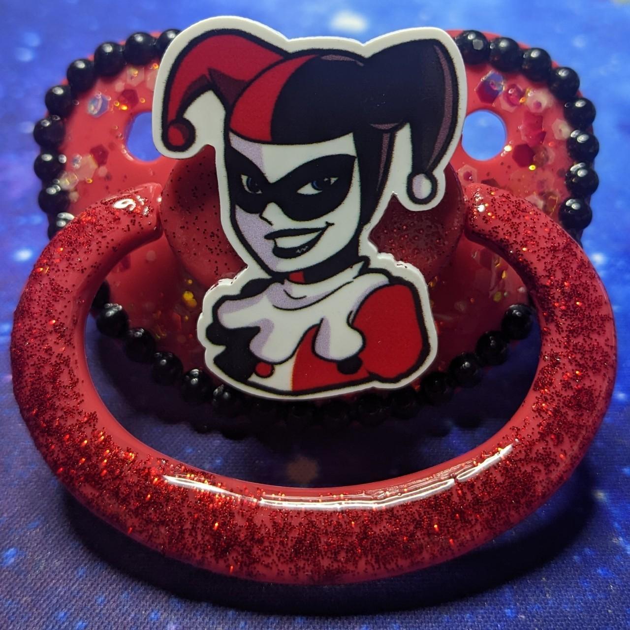 Red adult pacifier with Harley Quinn from the 90s... - Depop