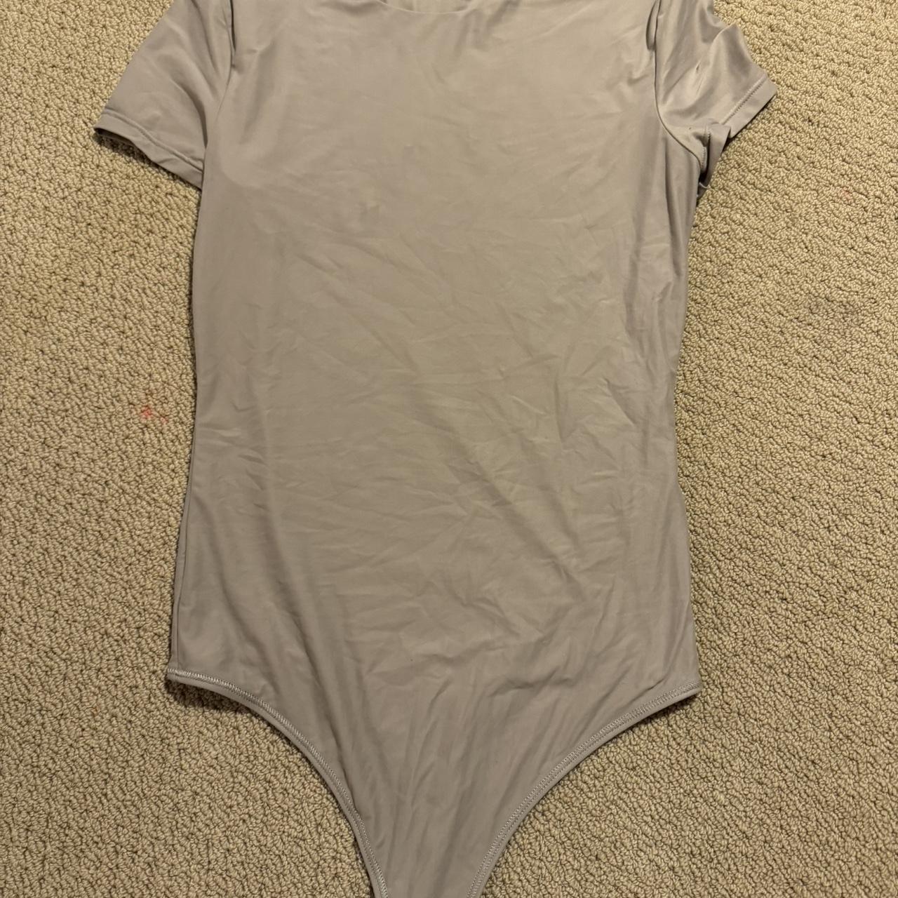 tan body suit. silky skin tight. never worn - Depop