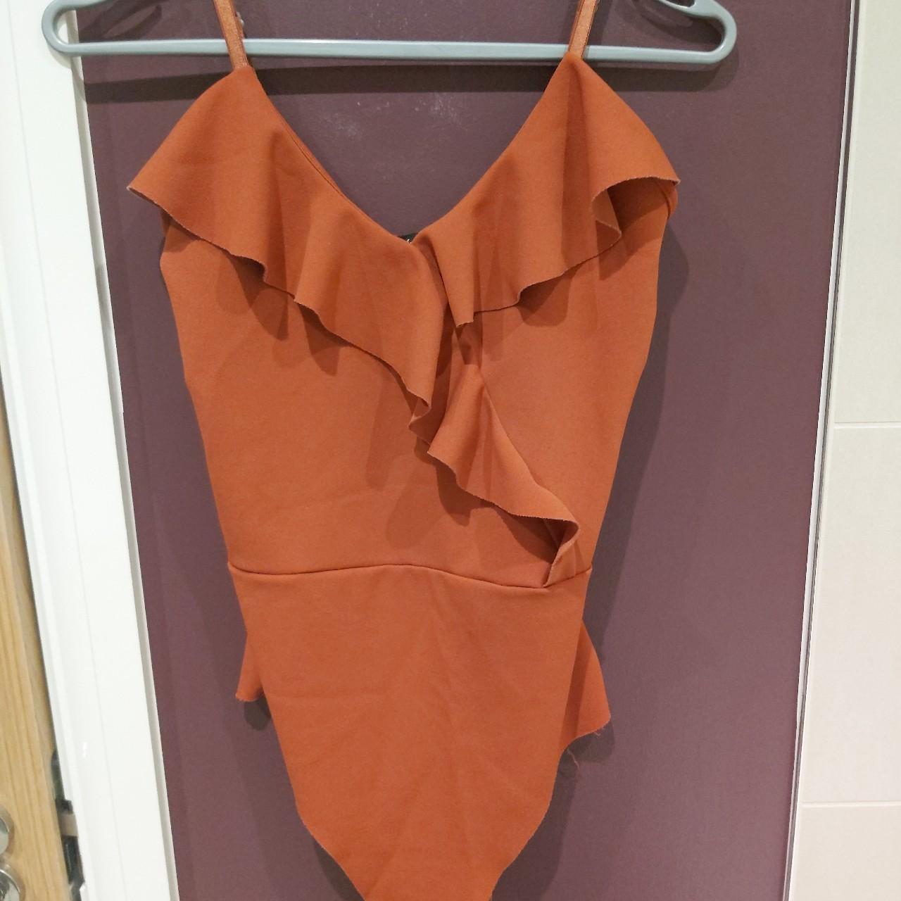Orange body suit Orange frill body suit, size 8, in... - Depop