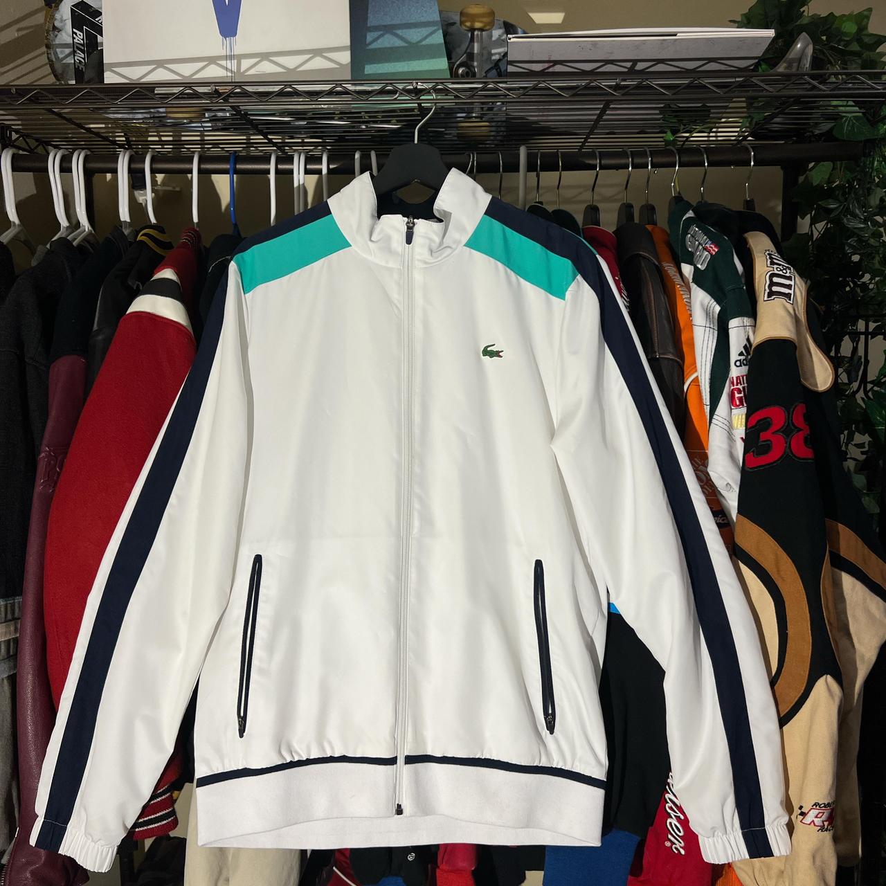 White Lacoste zip up jacket with blue and green stripes - Depop