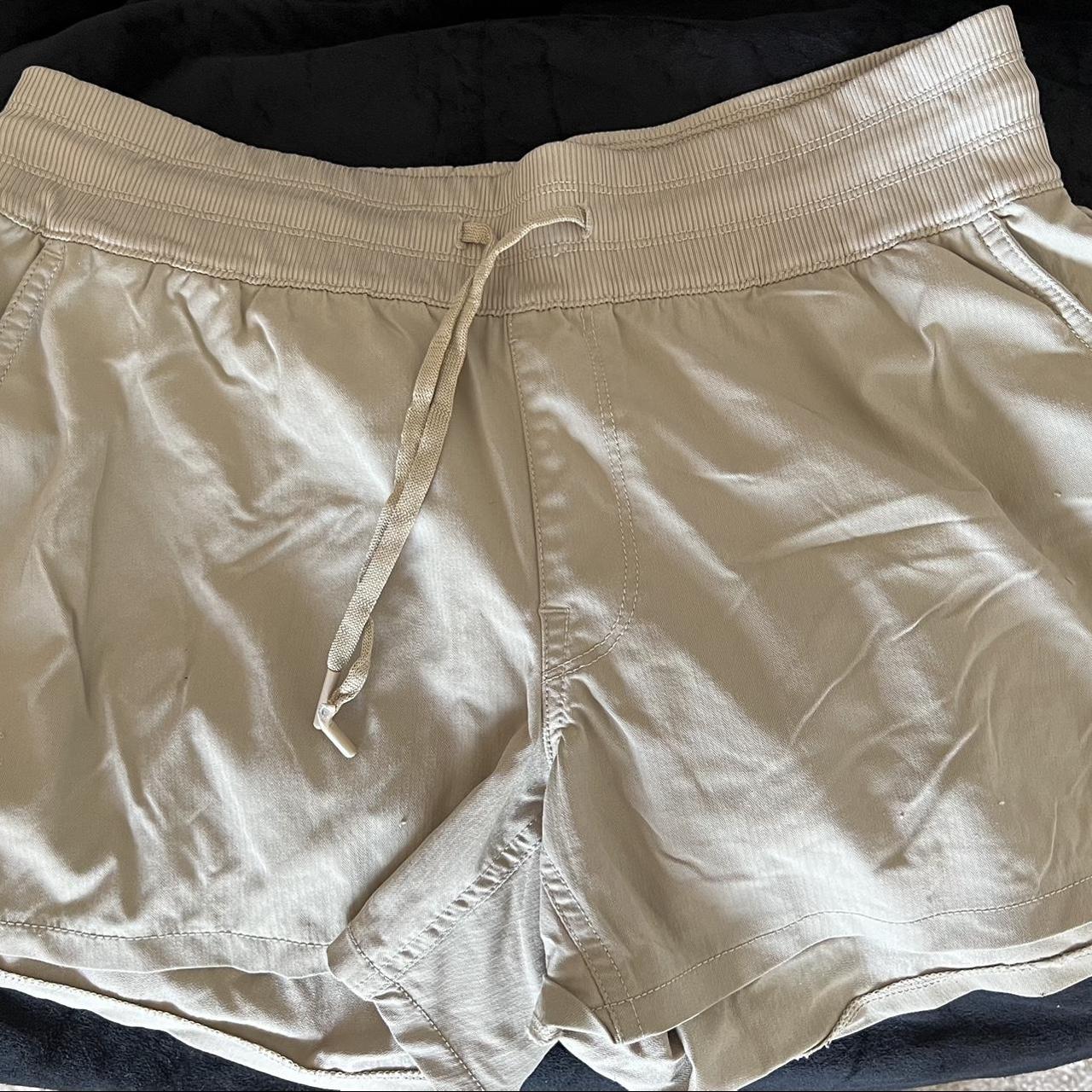 NORTH FACE Women’s tan running shorts. Note one lace... - Depop