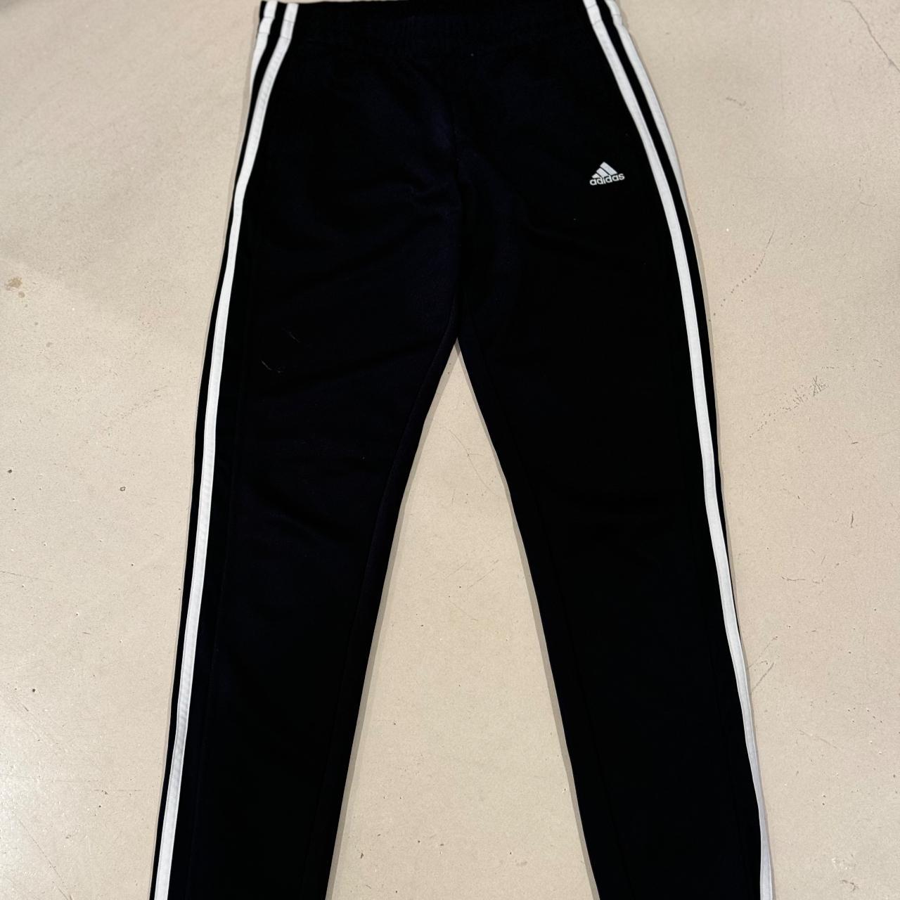 black Adidas pants with pockets and zip up seam near... - Depop