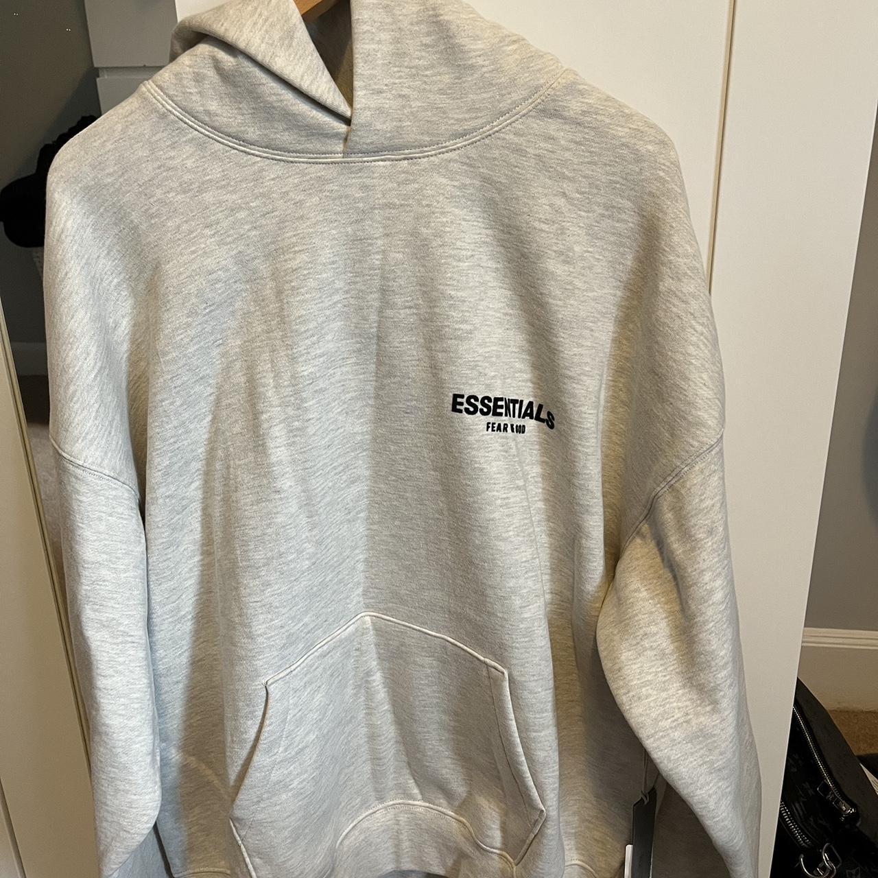 Fear of god essentials light grey hoodie never been... - Depop