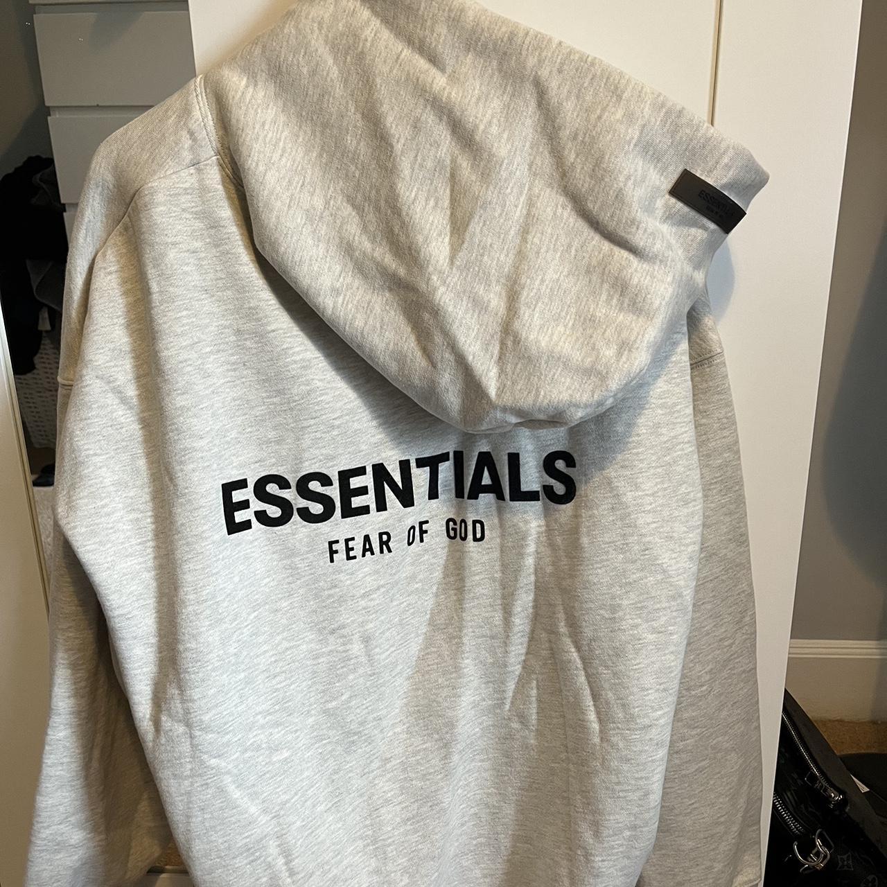 Fear of god essentials light grey hoodie never been... - Depop