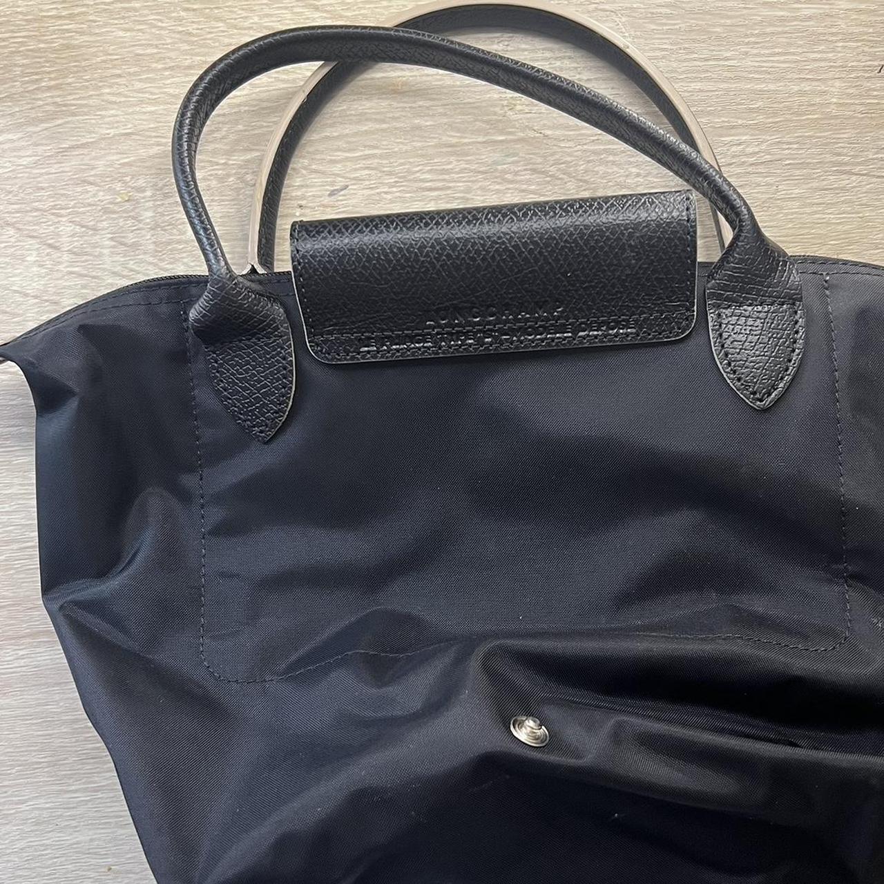 Small black longchamp bag with white logo. Slightly... - Depop