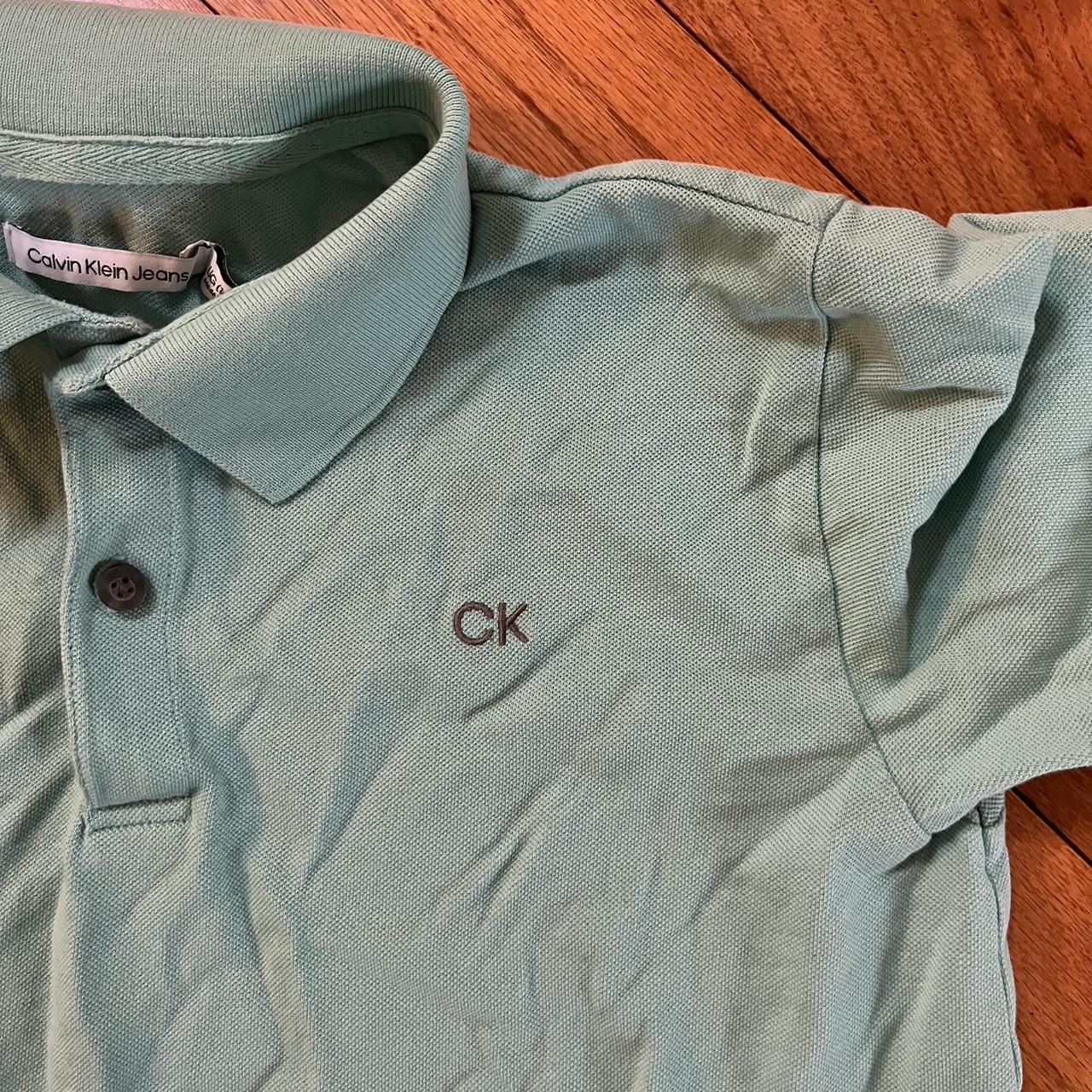 Calvin Klein tiffany blue polo kid’s size large (14/16) - Depop