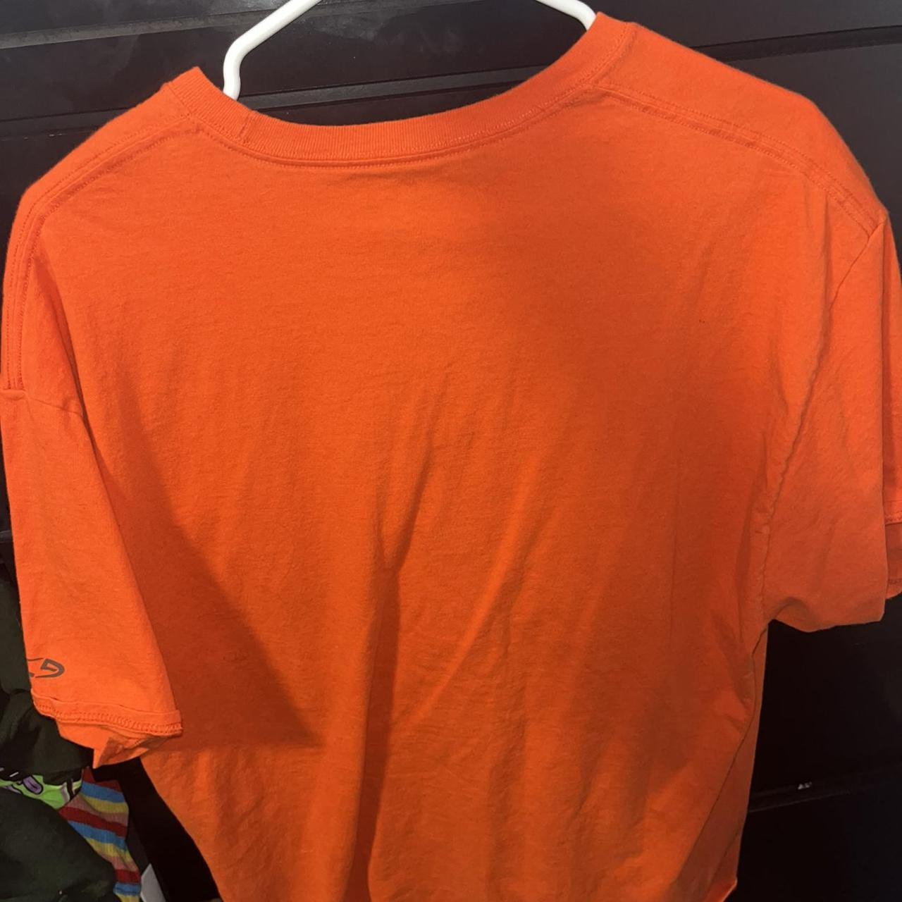 bright, neon orange Champion shirt. Purchased from a... - Depop