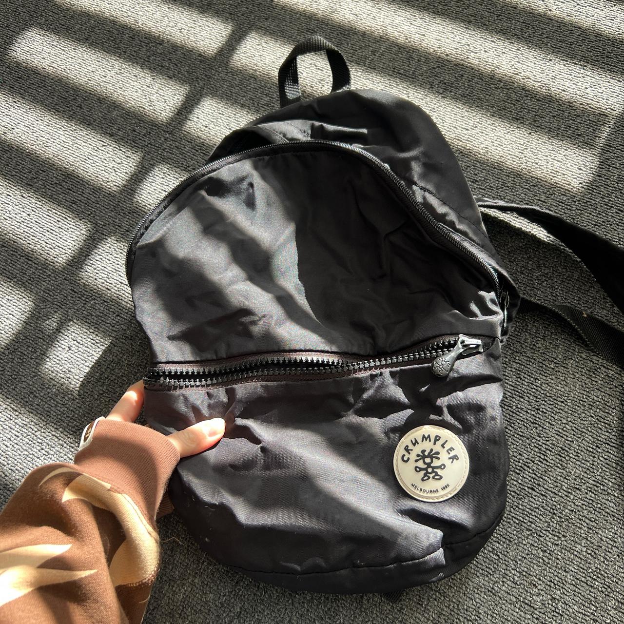 Crumpler black and white backpack. Inside is... - Depop