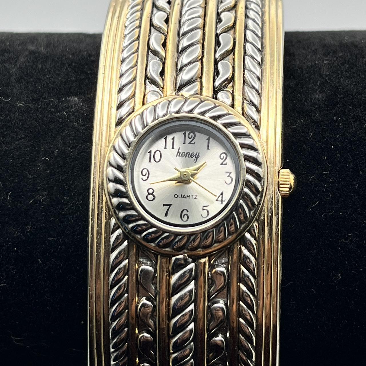 Avon Women's Black and Gold Watch | Depop